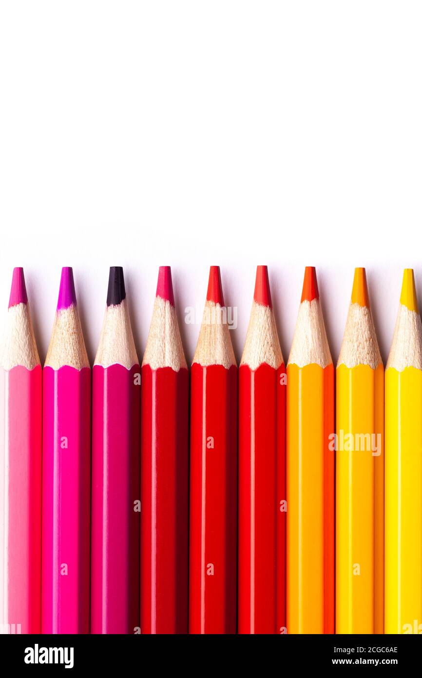 multi-colored wooden pencils in red shades on a white isolated ...