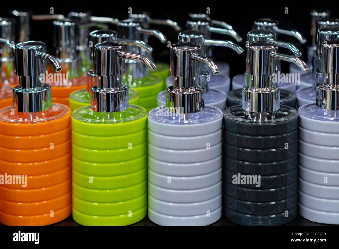 Cosmetic dispensers on a black background Stock Photo - Alamy