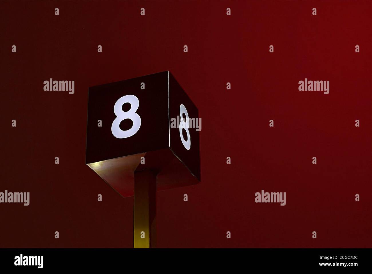 Number eight on a pillar in the parking lot. On street Stock Photo - Alamy