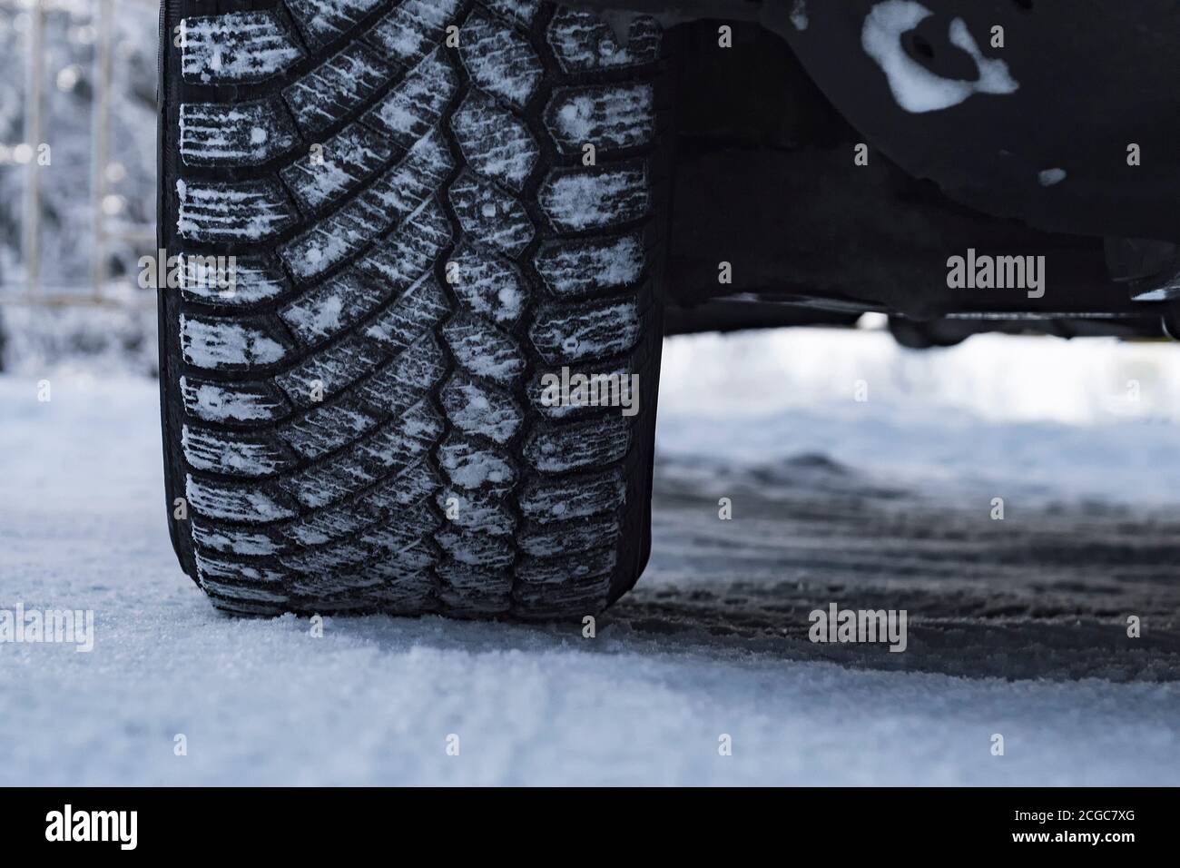 The wheel of the car is coated in winter tires in the snow Stock Photo ...