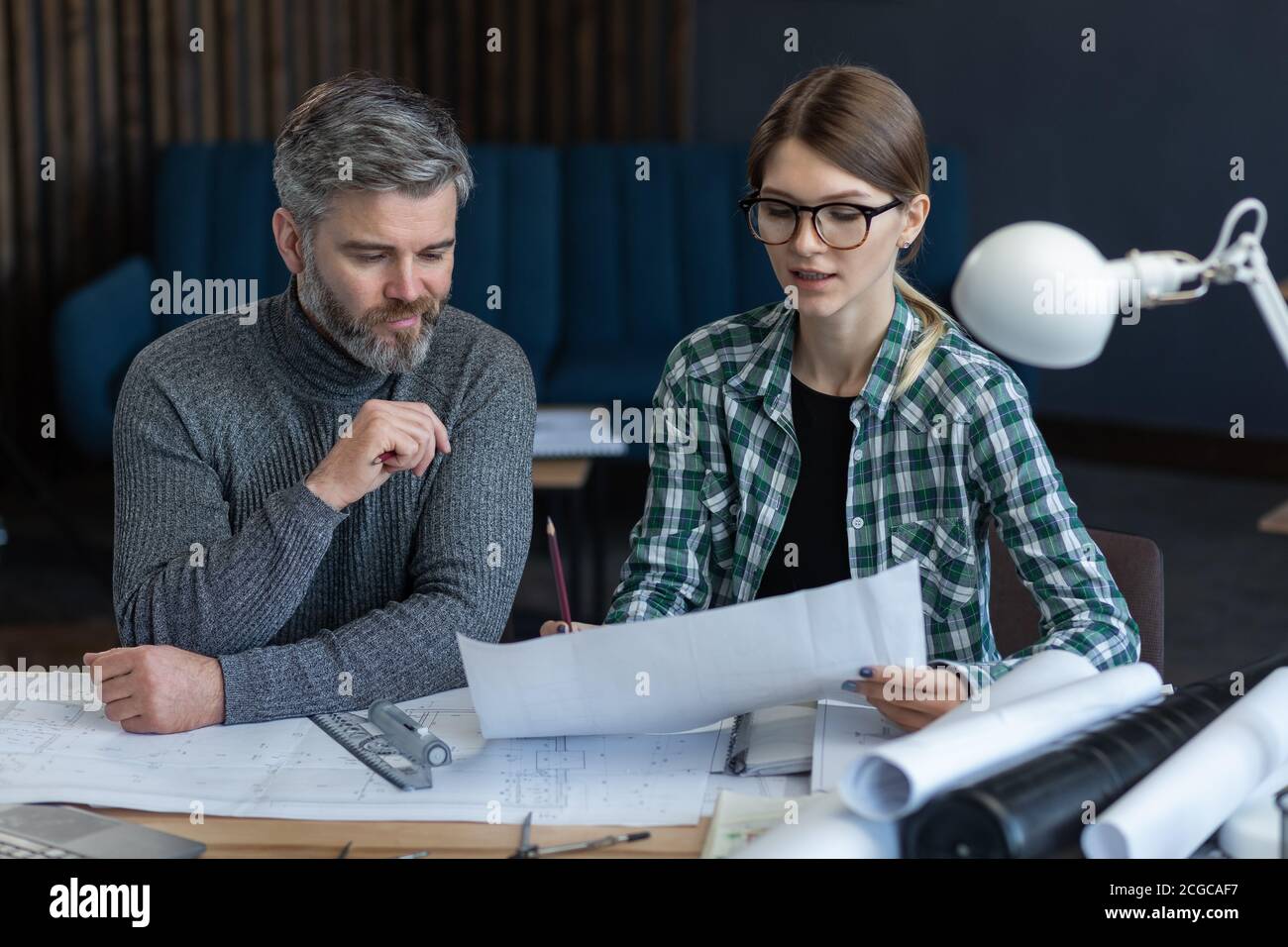 Interior designers team working in office with blueprints and architect ...