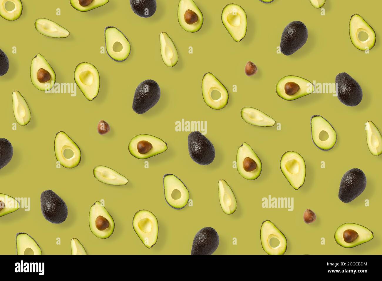 Avocado. Background made from isolated Avocado pieces on olive color ...