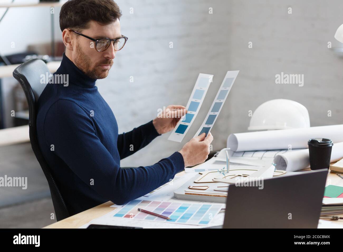 Architect working in office with color palette. Engineer select colors ...