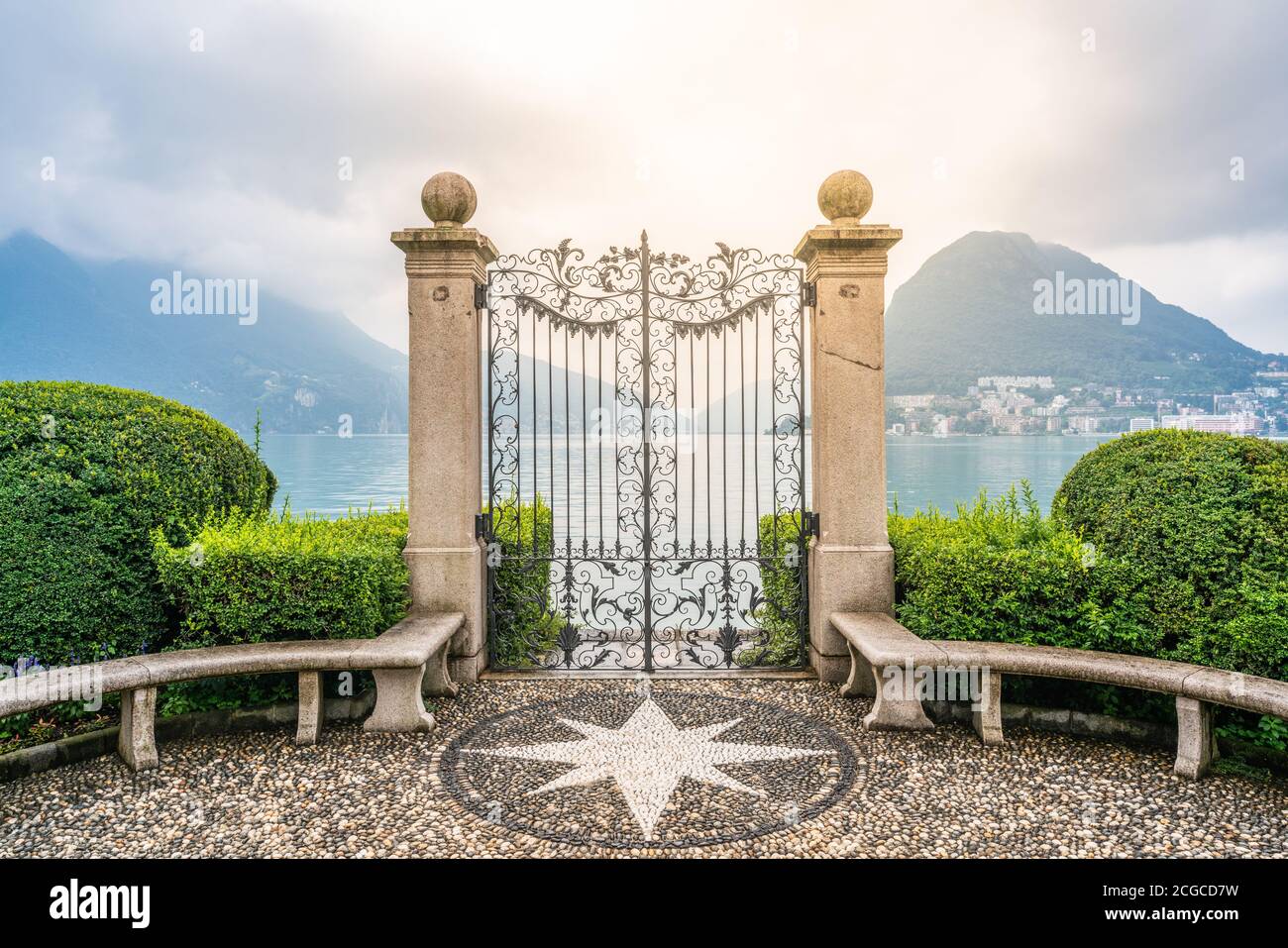 Old wrought-iron gate on Lake Lugano banks in Parco Civico Ciani public ...