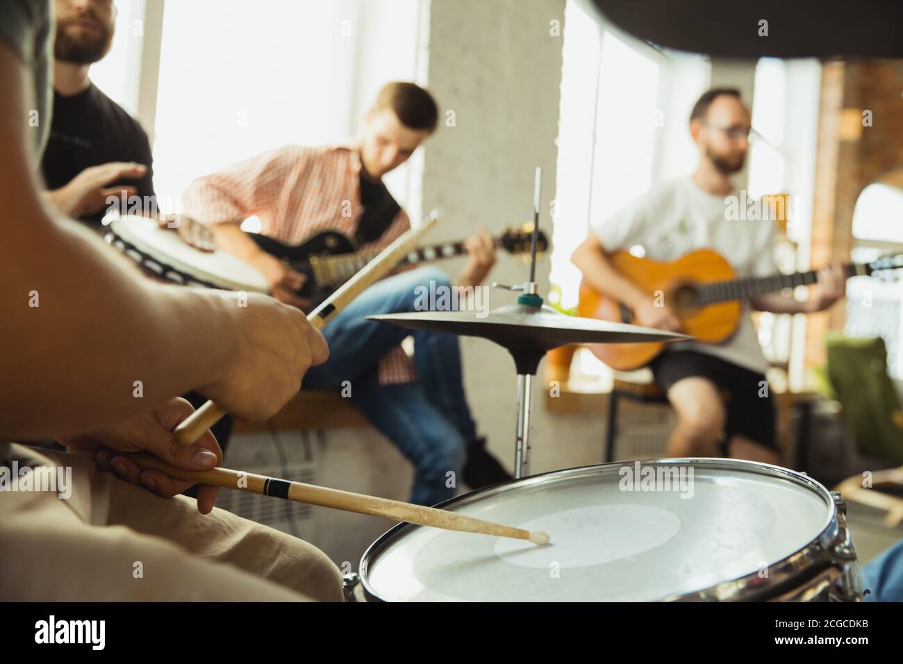 Songs. Musician band jamming together in art workplace with instruments ...
