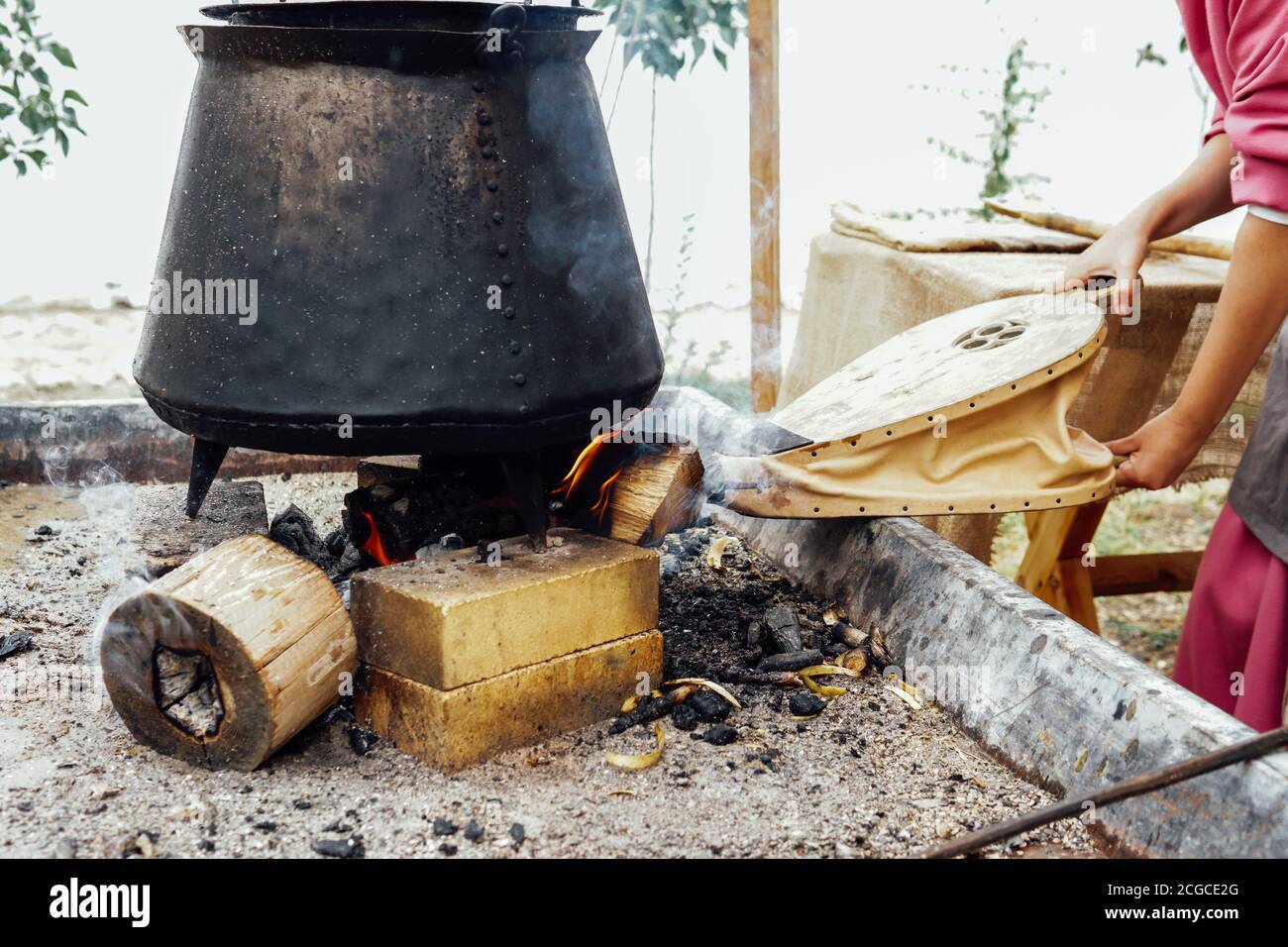 Cooking delicious hot food on a fire fire Stock Photo - Alamy