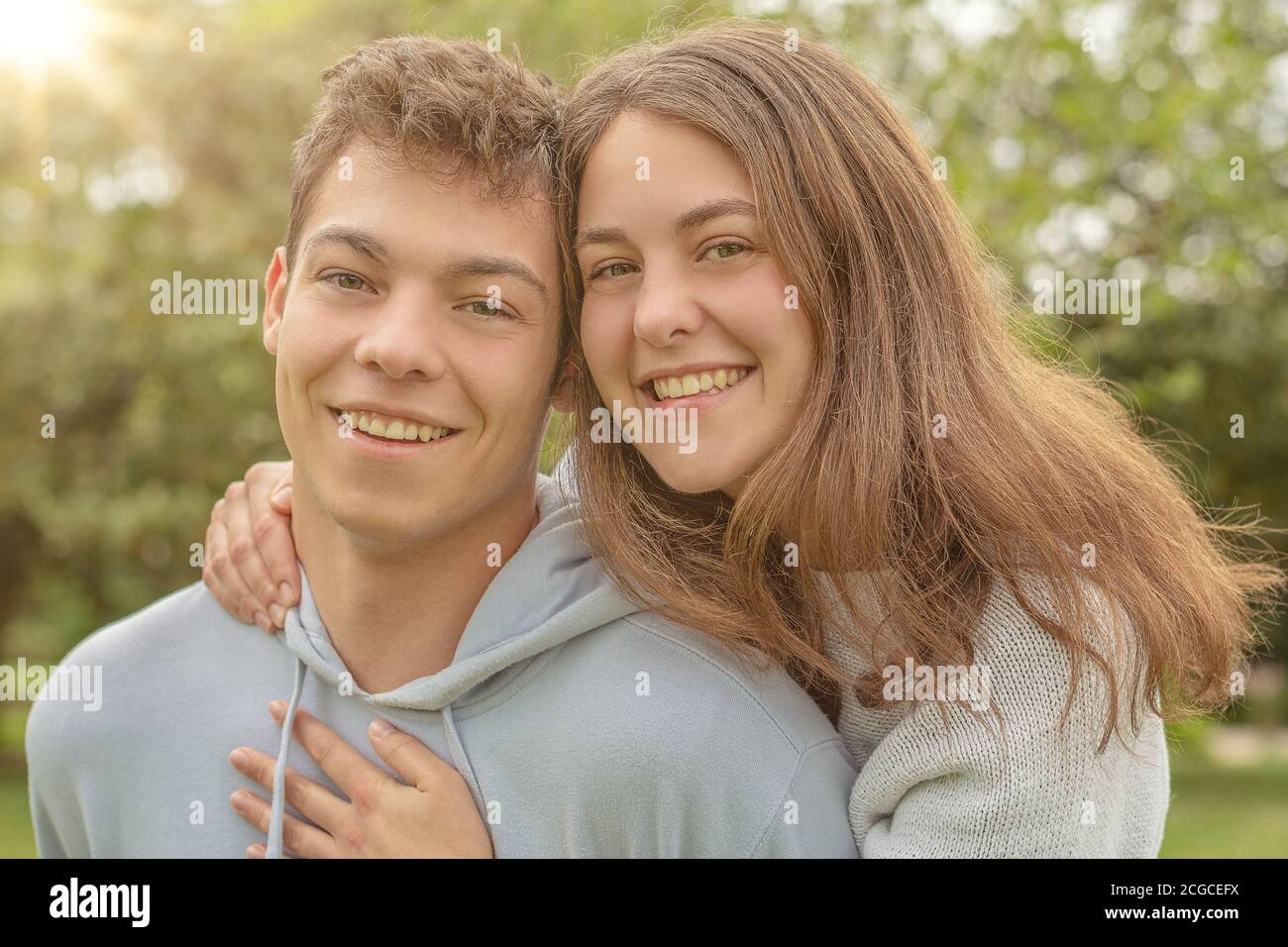 Christian friendship. Two happy friends laughing and hugging outdoors ...