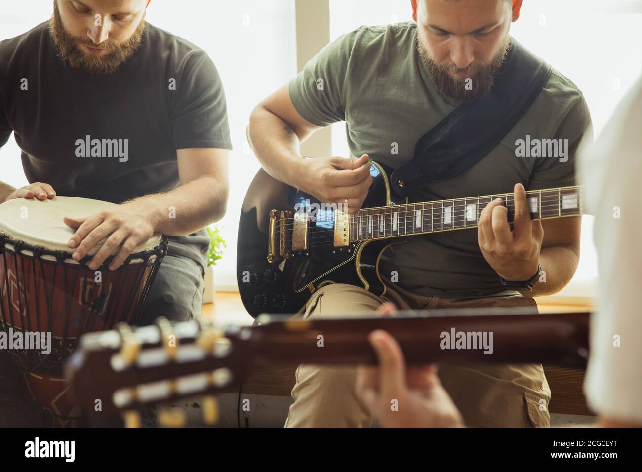 Festival. Musician band jamming together in art workplace with ...