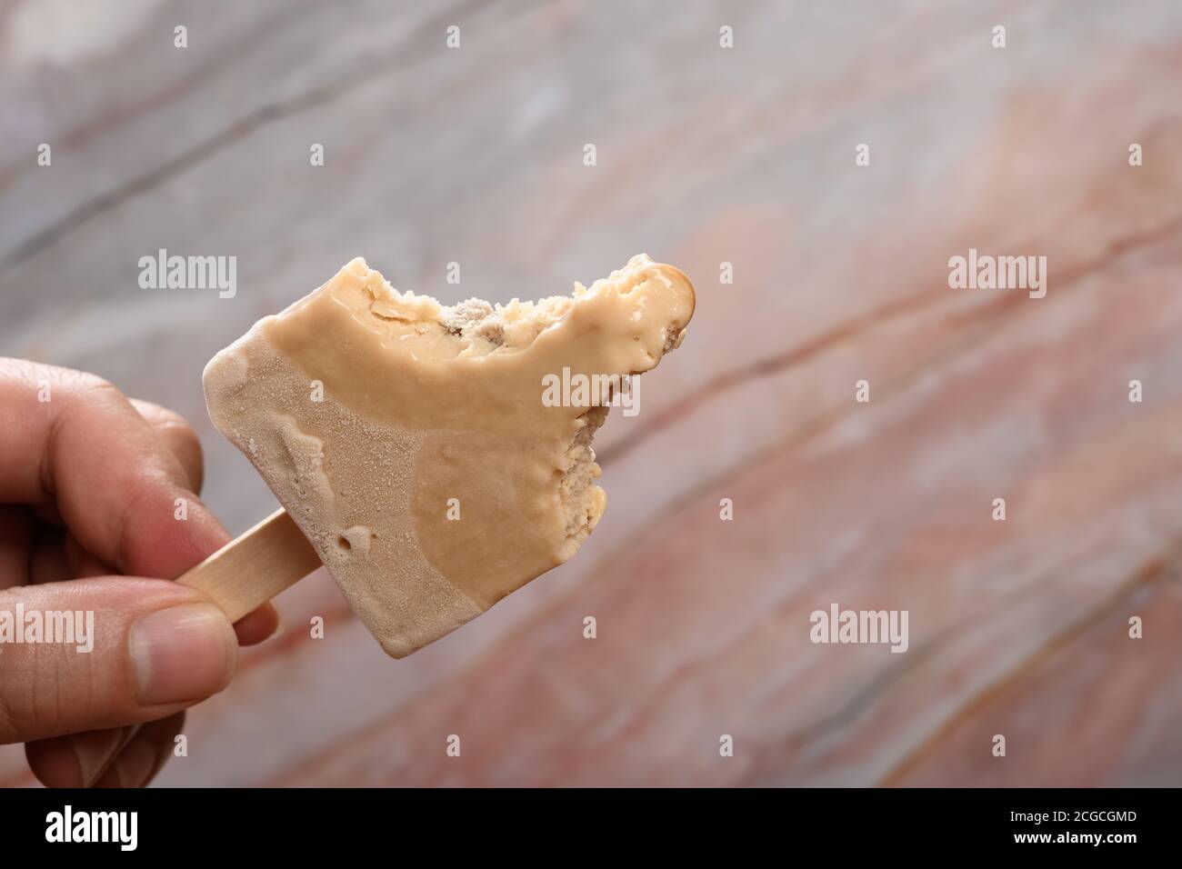 hand holding a half eaten tapioca milk tea flavor popsicle Stock Photo ...