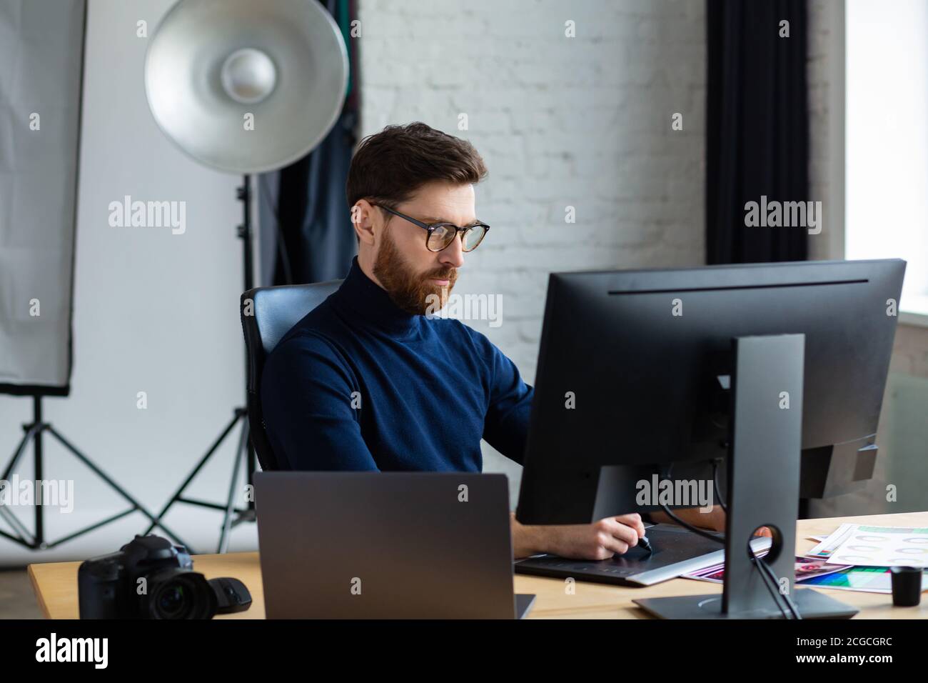 Retouching images in special program.Portrait of graphic designer ...