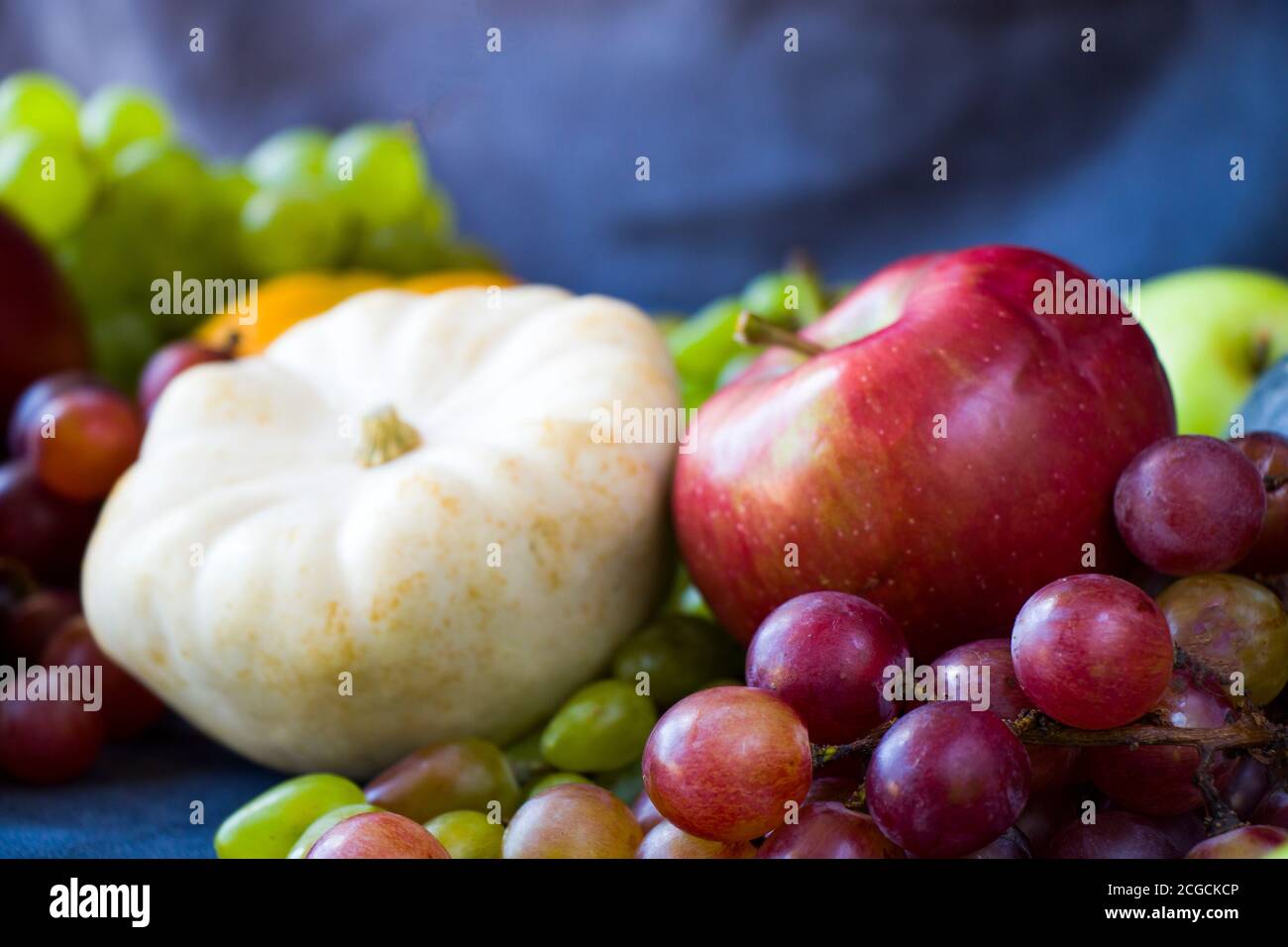Autumn and fall harvest, pumpkin, apple, grape and pattison on the blue ...