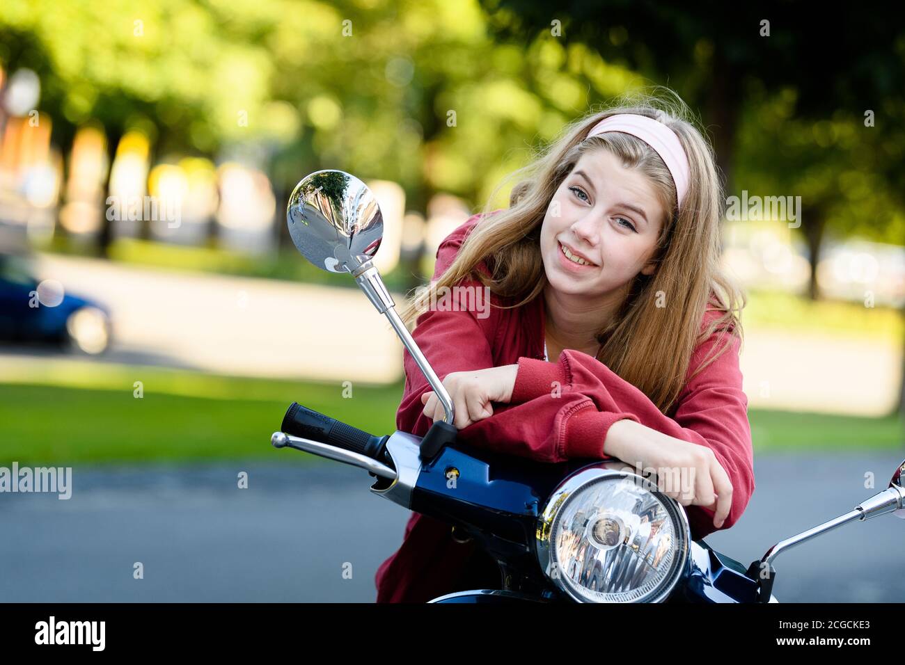 Young girl student with motorbike Stock Photo - Alamy