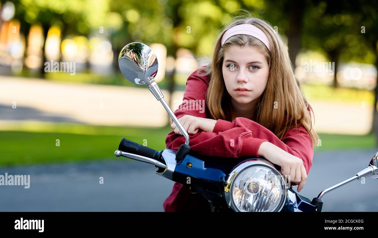 Young girl student with motorbike Stock Photo - Alamy
