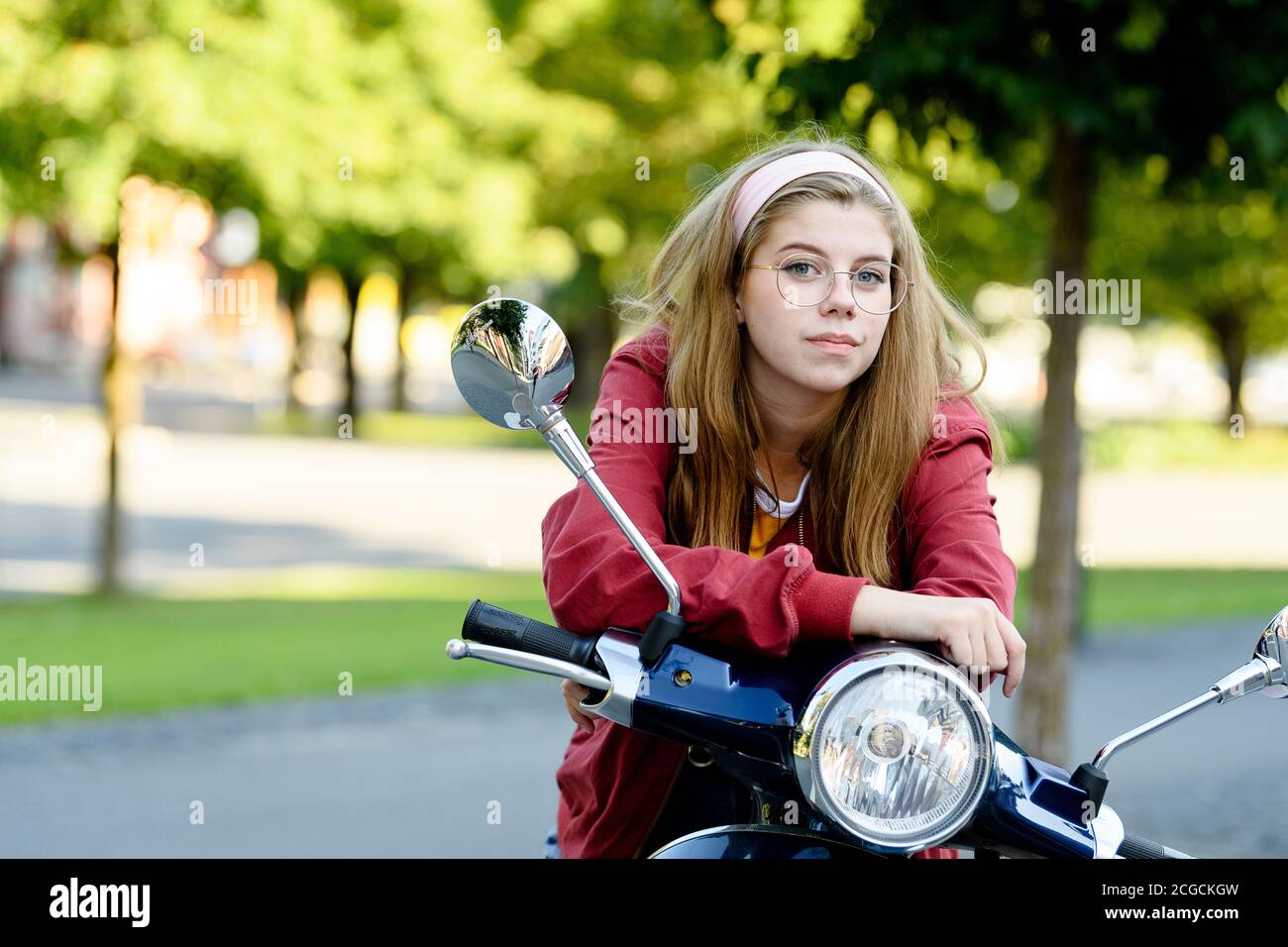 Young girl student with motorbike Stock Photo - Alamy
