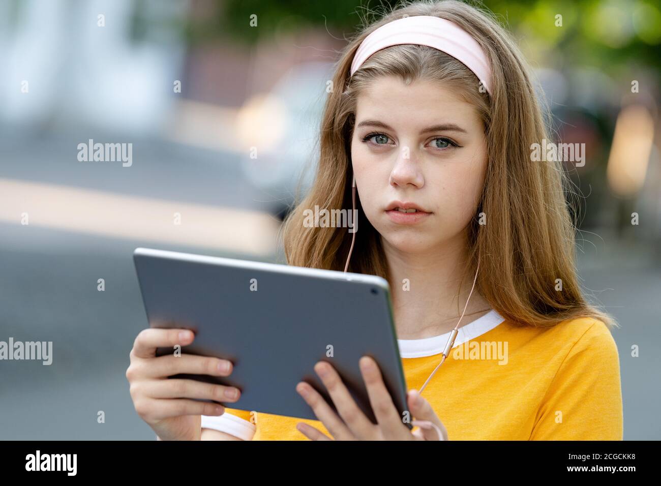 Young girl with tablet and urban background Stock Photo - Alamy