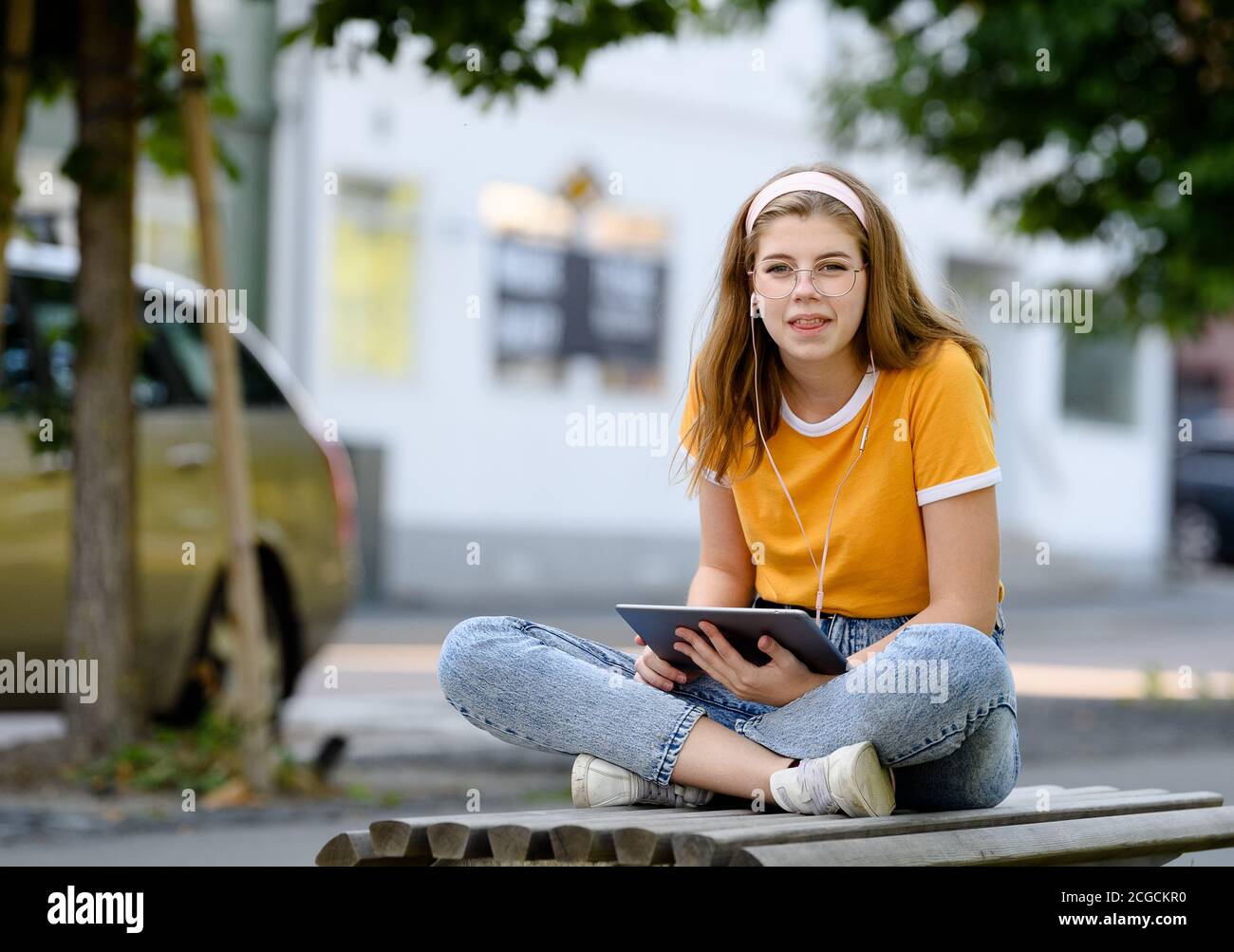 Young girl with tablet and urban background Stock Photo - Alamy