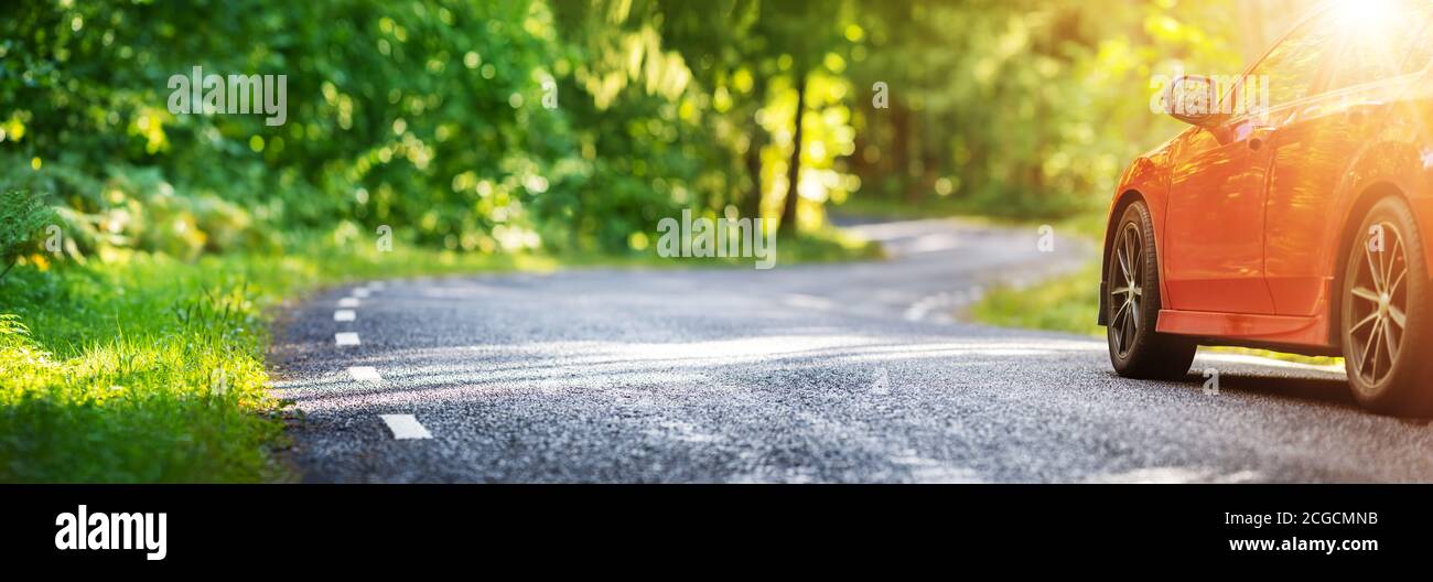 red car on asphalt road in summer Stock Photo - Alamy