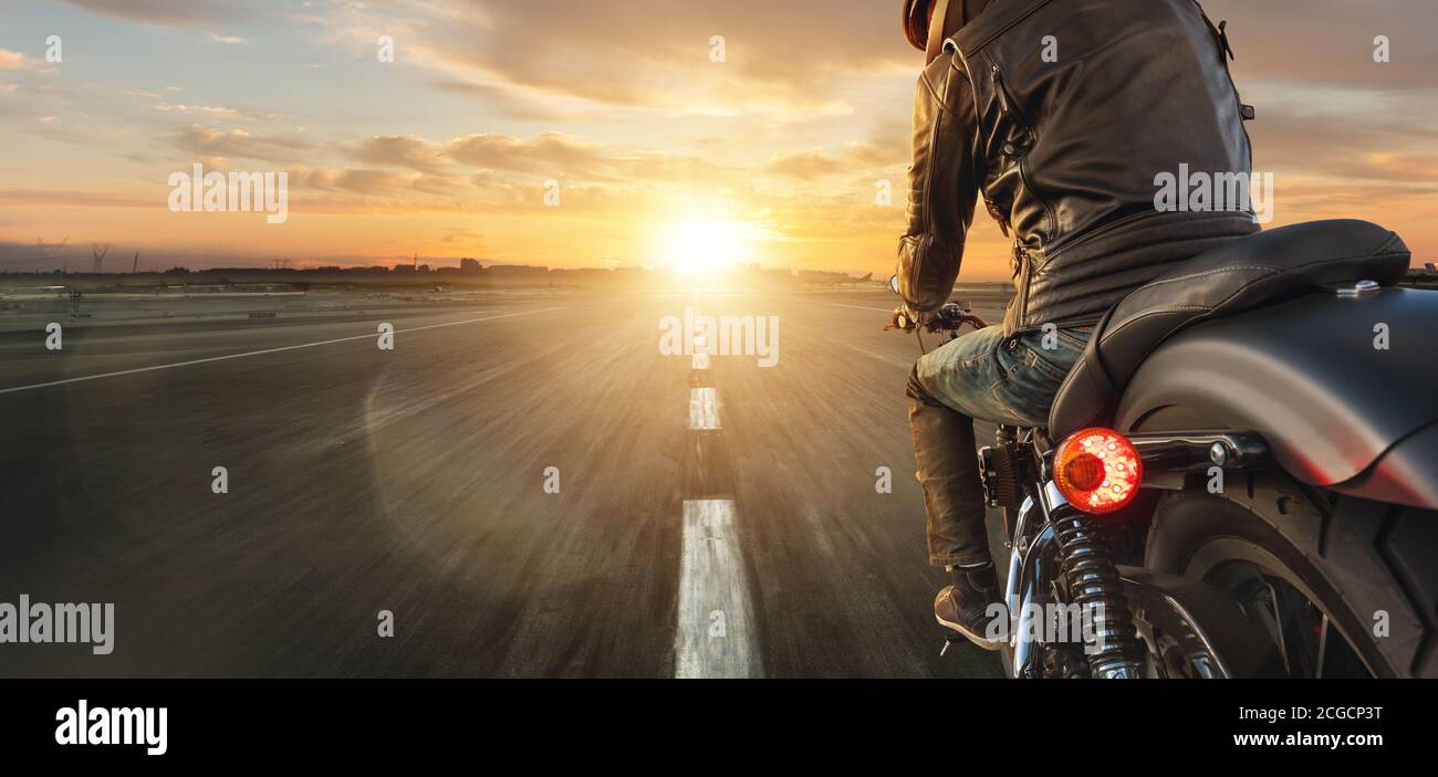 Motorcycle driver riding alone on asphalt motorway. Outdoor photography ...