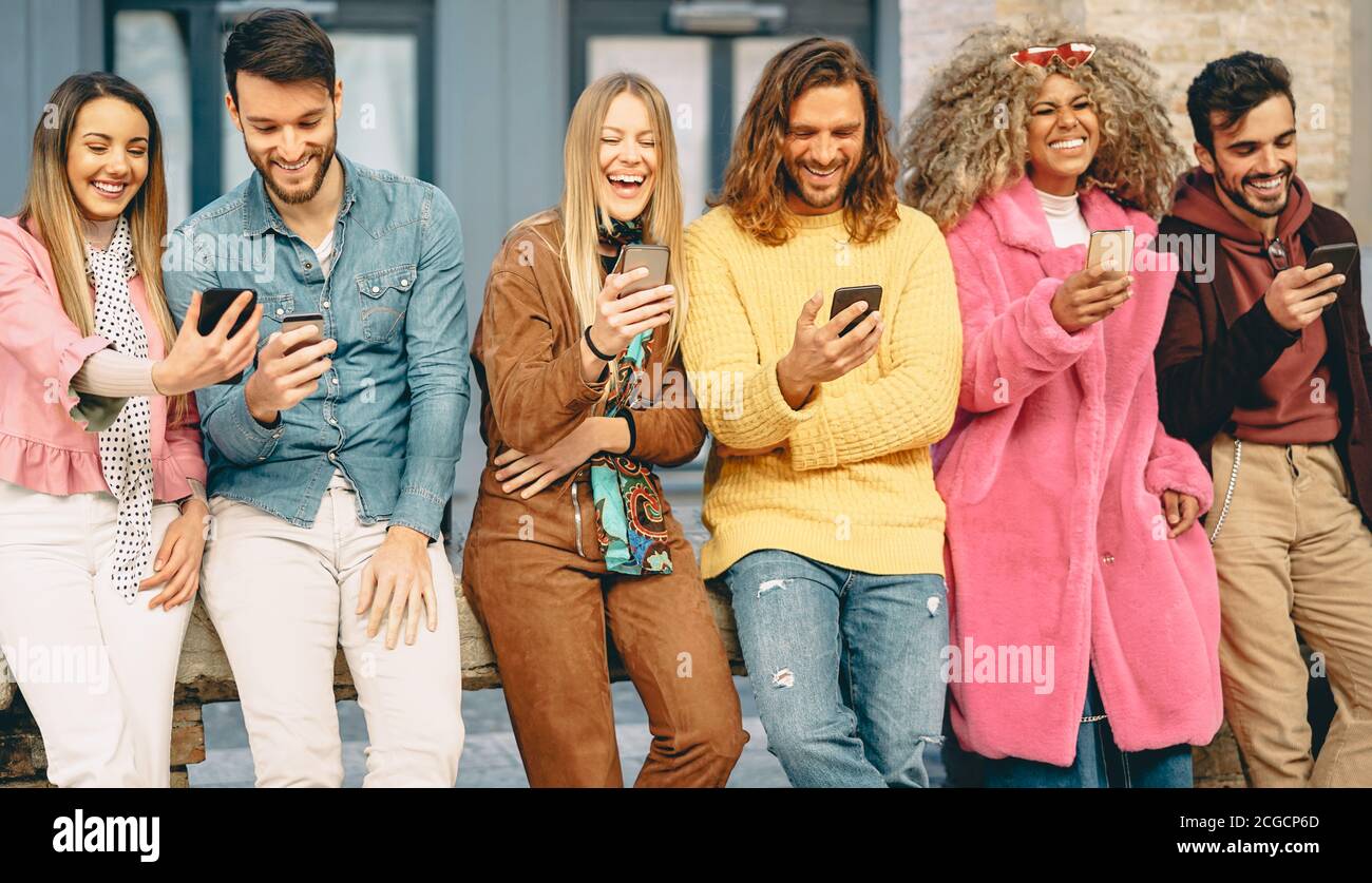 Group of trendy friends using mobile smartphones outdoor - Millennial ...
