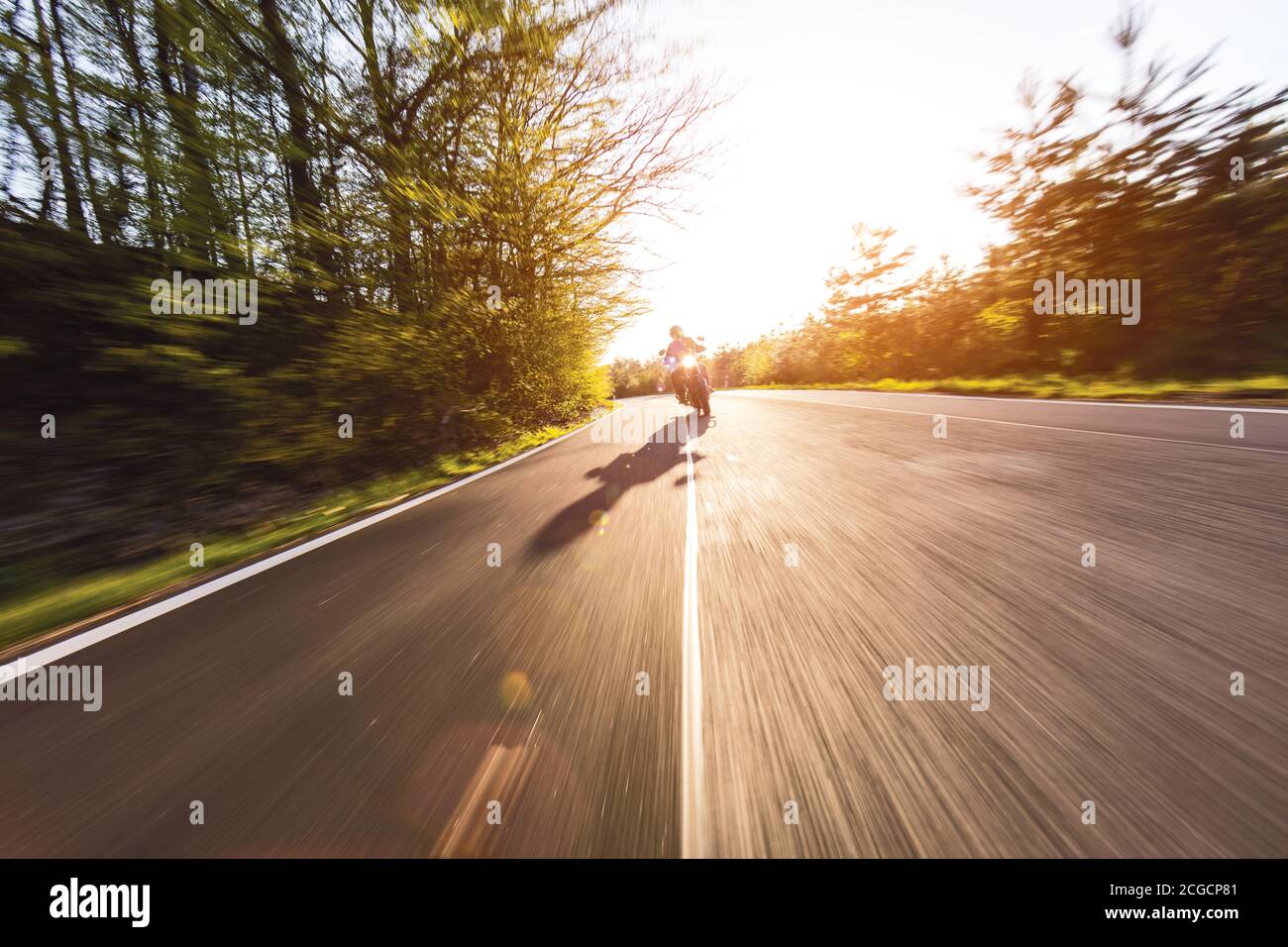 Motorcycle driver riding in European road. Outdoor photography ...