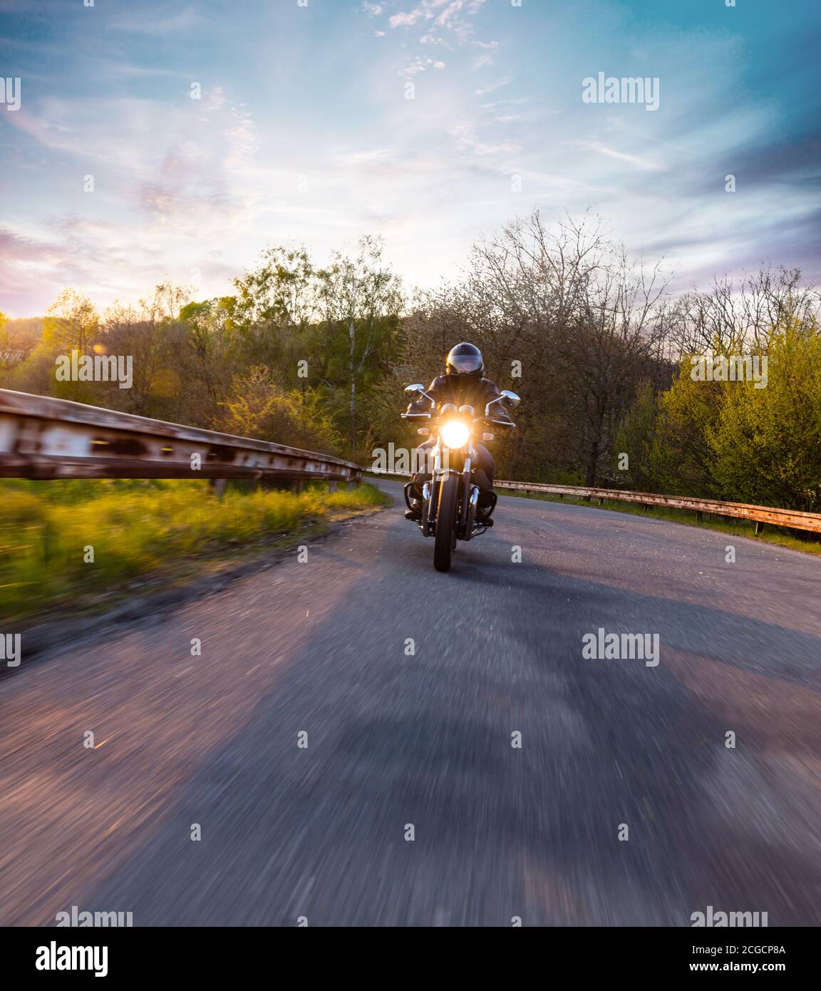 Motorcycle driver riding in European road. Outdoor photography ...