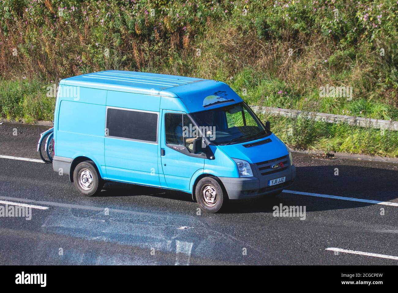 2011 blue Ford Transit 115 T330M FWD window van; Vehicular traffic ...