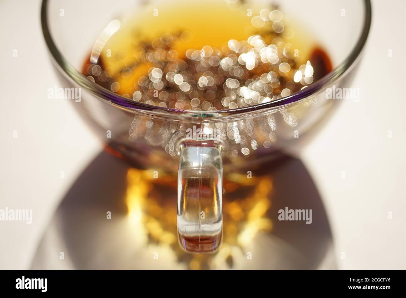 Transparent glass cup with black flower tea. Incredibly beautiful ...