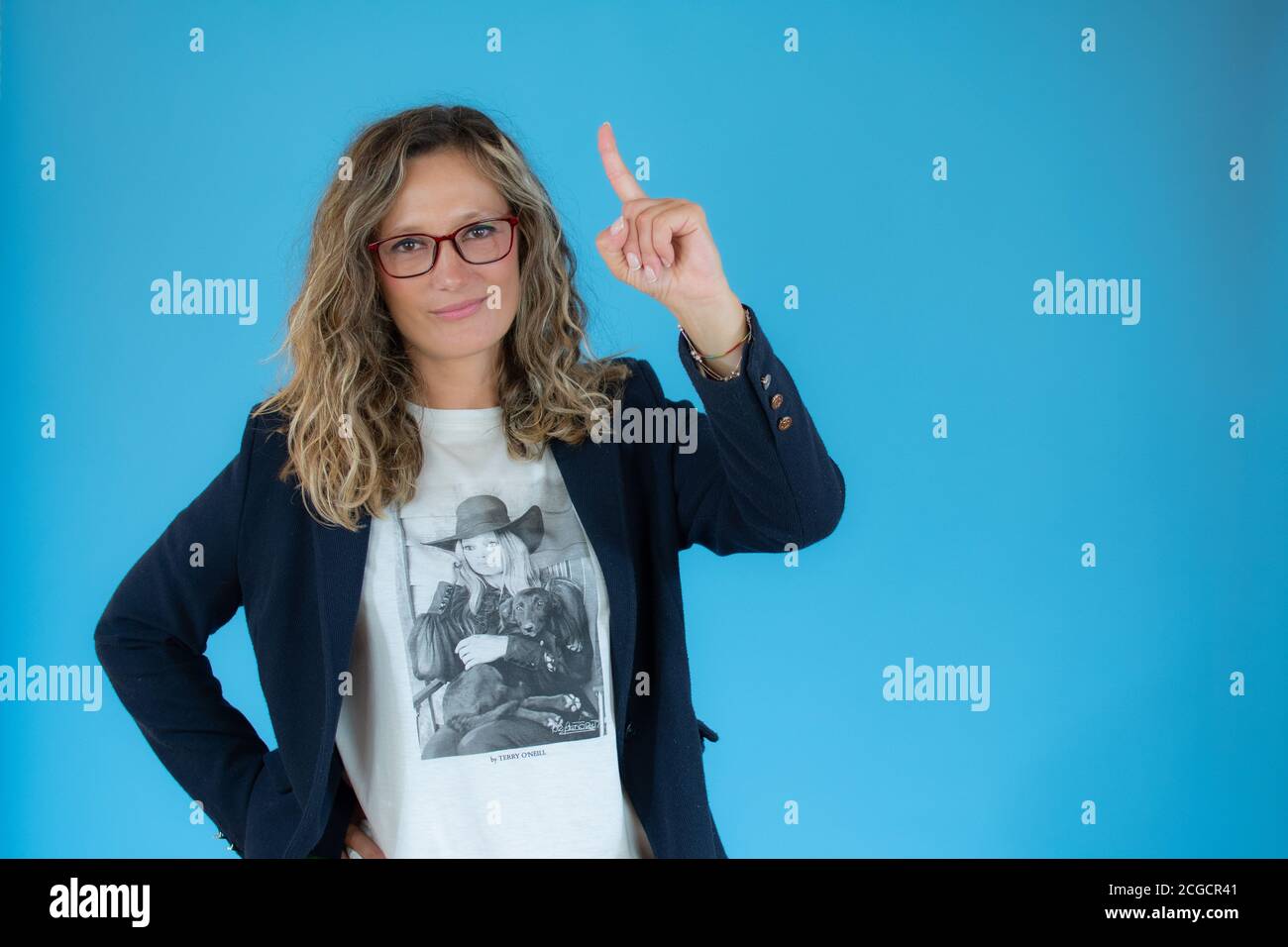 Business woman with finger up gesture on blue background Stock Photo ...