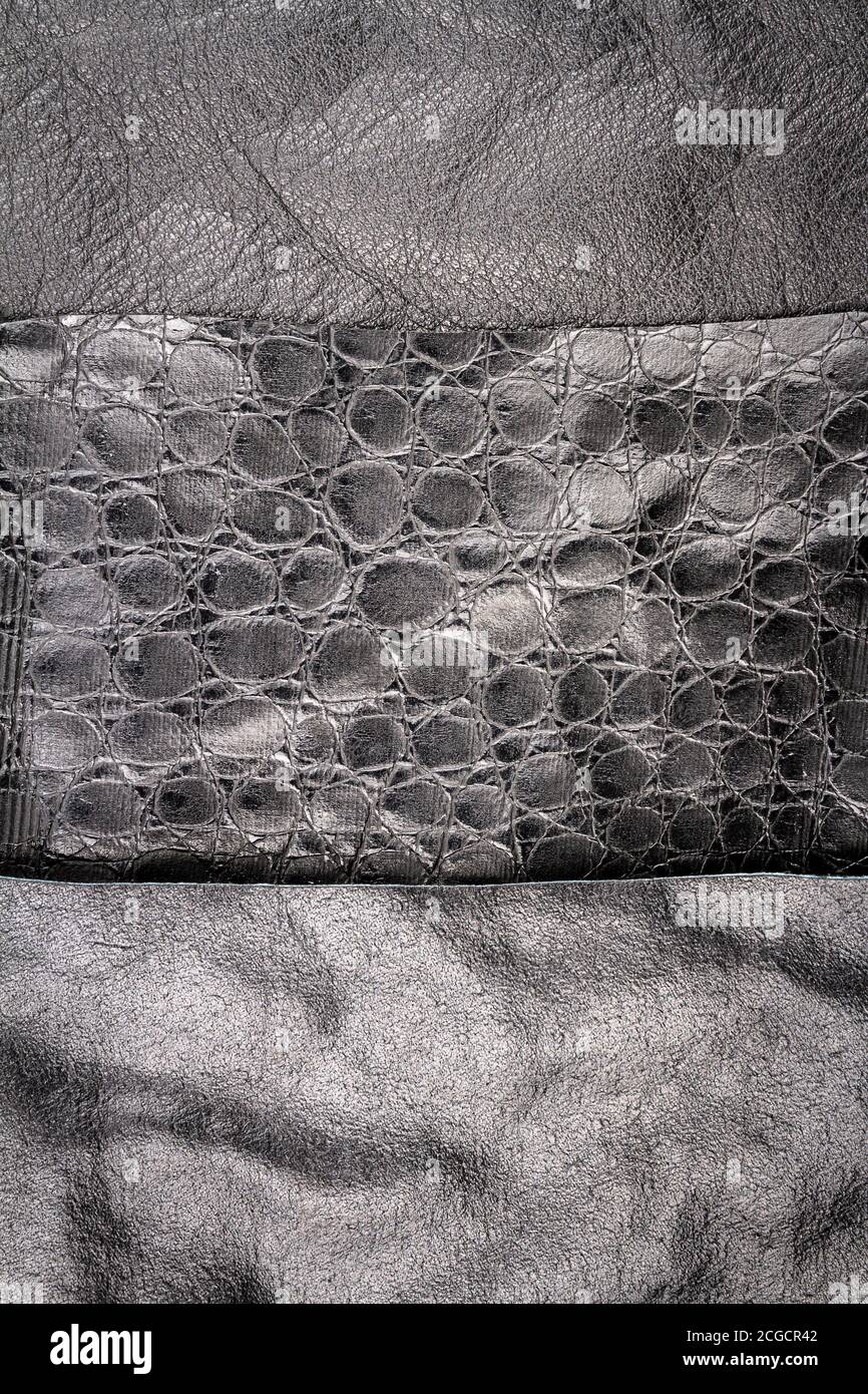 Black leather and fake artificial alligator skin textures background ...