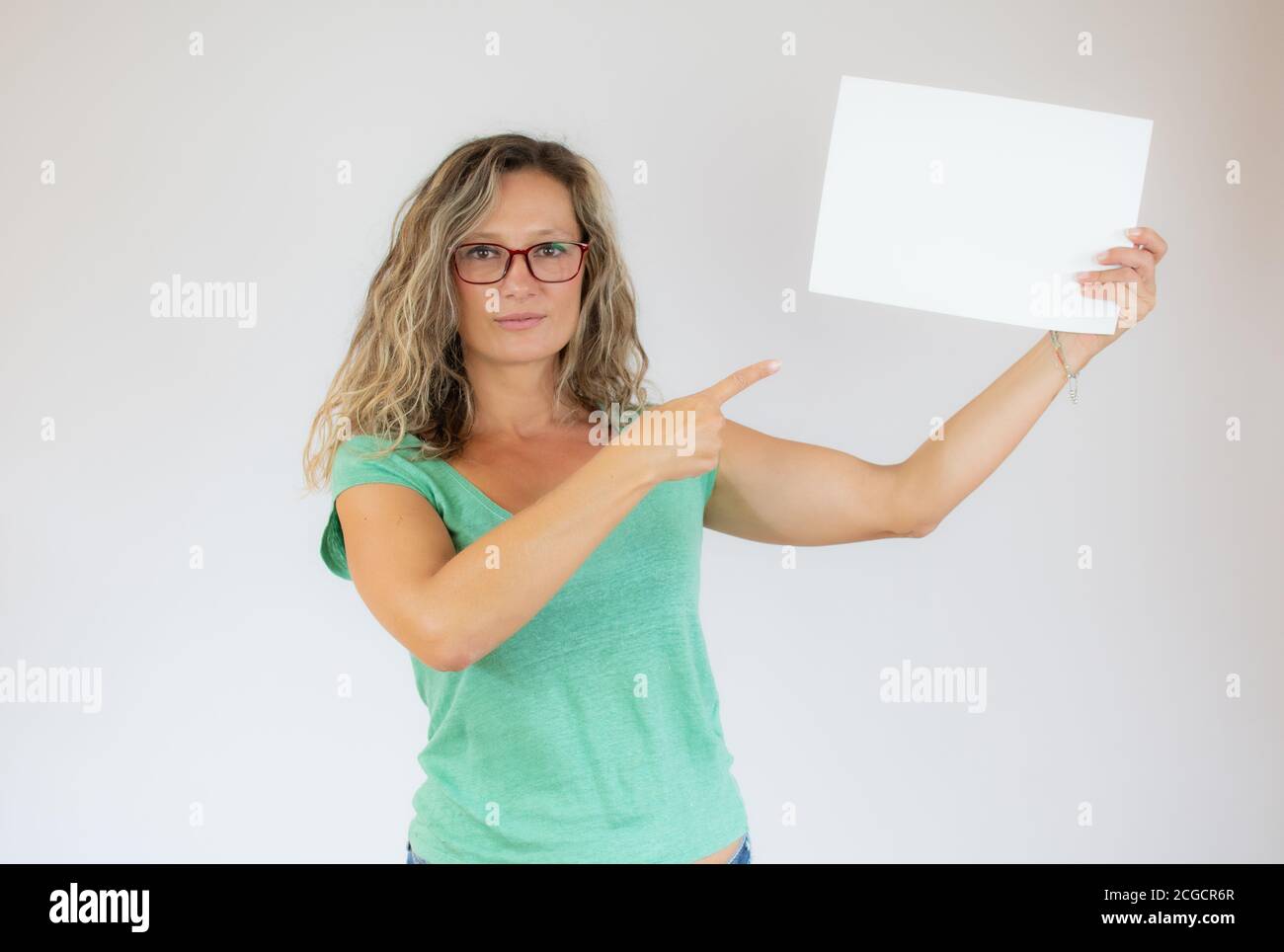 Beautiful woman with glasses pointing to a paper Stock Photo - Alamy