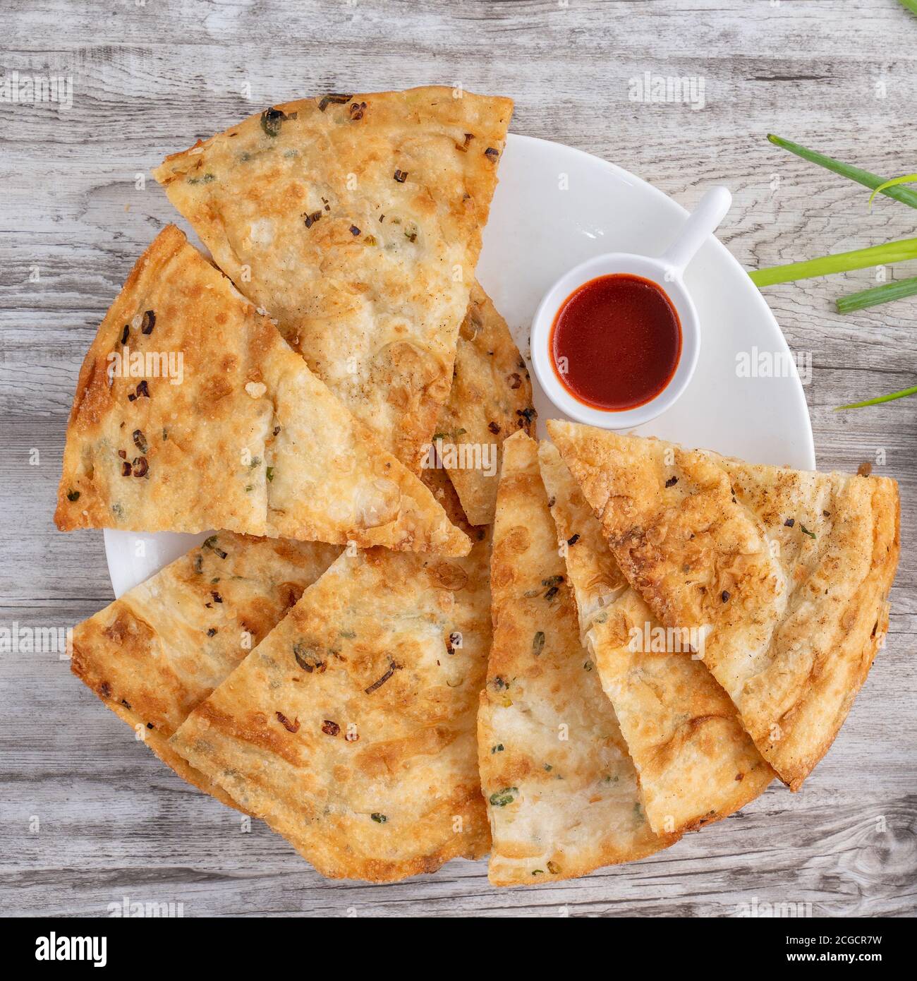 Taiwanese food - delicious flaky scallion pie pancakes on bright wooden ...