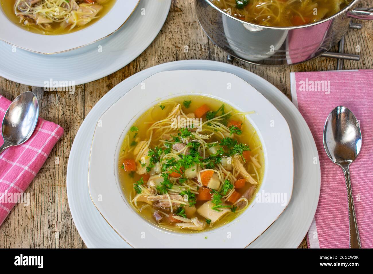 chicken soup dinner table with plate, spoon, pot Stock Photo - Alamy