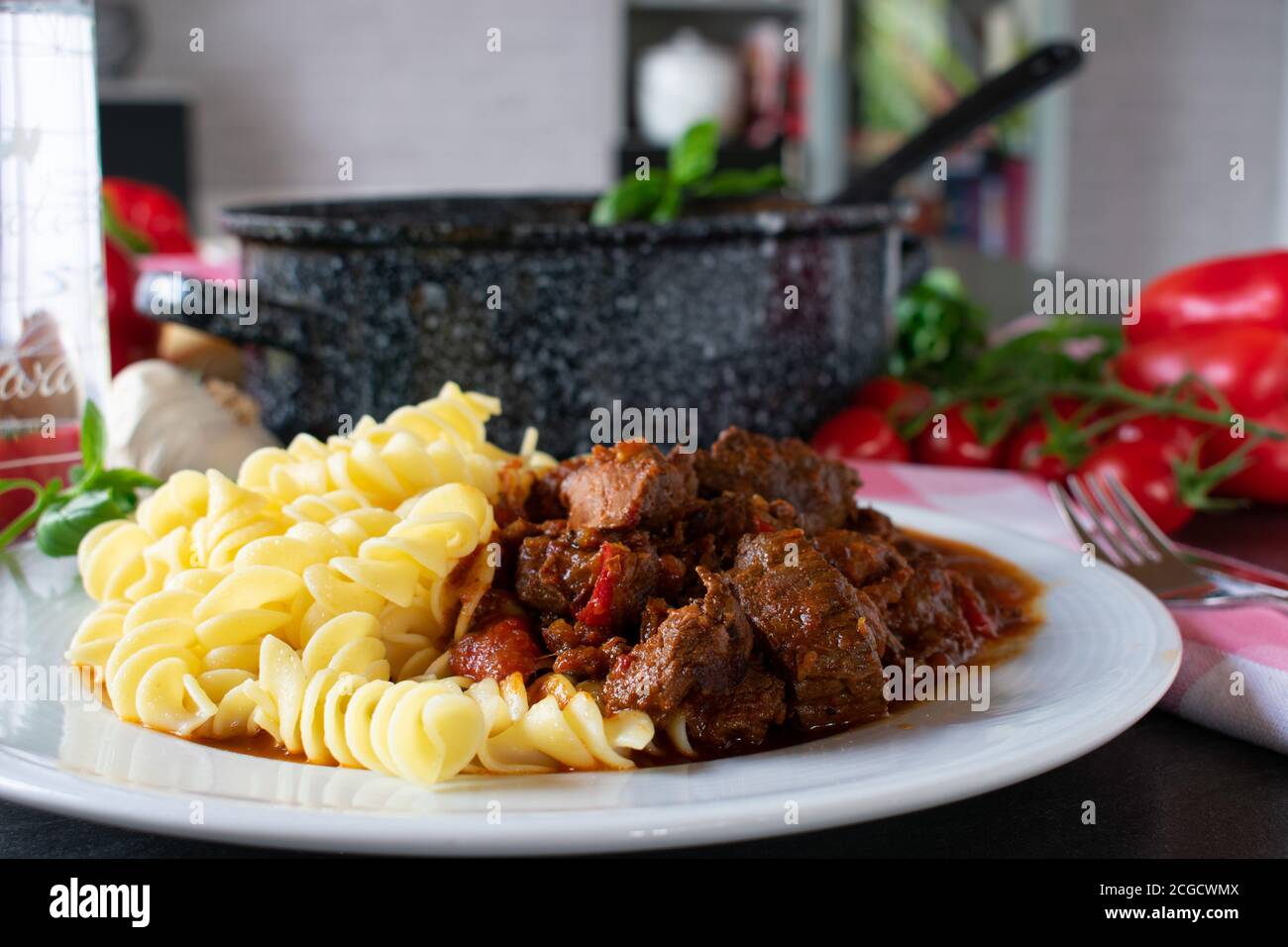 hungarian goulash served with noodles on a plate at home - homemade ...