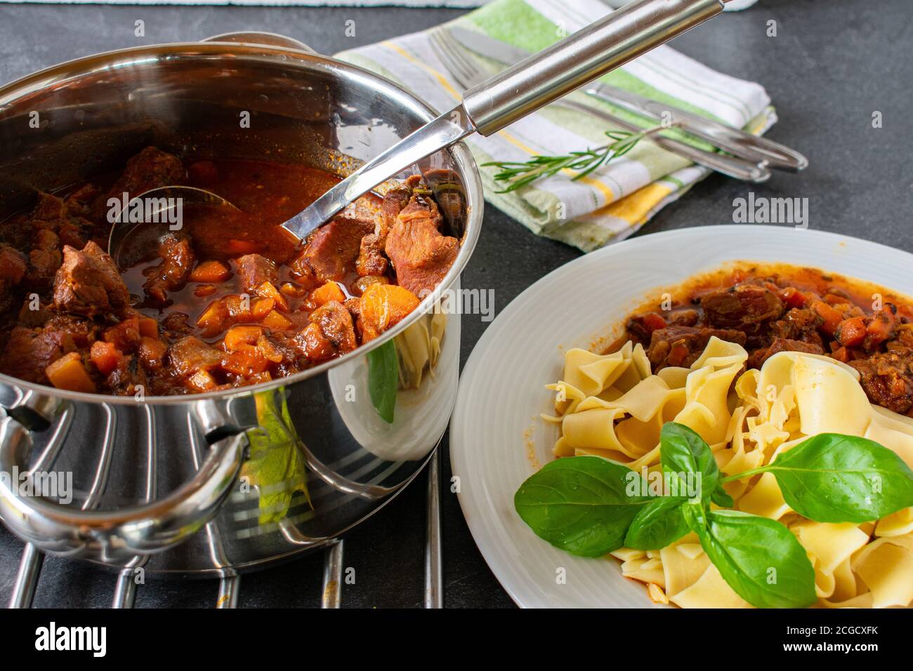 fresh cooked braised pork stew with pasta served in a pot Stock Photo ...