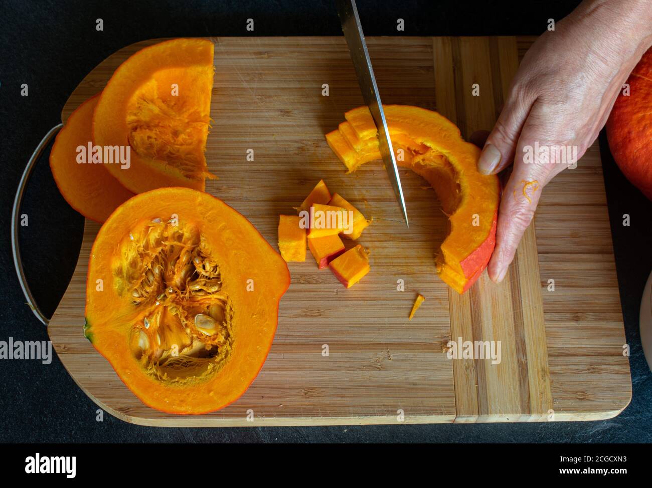 raw and uncooked pumpkin cut into cubes - preparation Stock Photo - Alamy