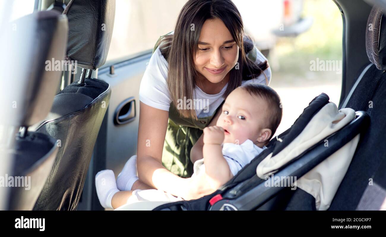 Little baby in a car seat in the car. Shot straight. The kid looks at ...