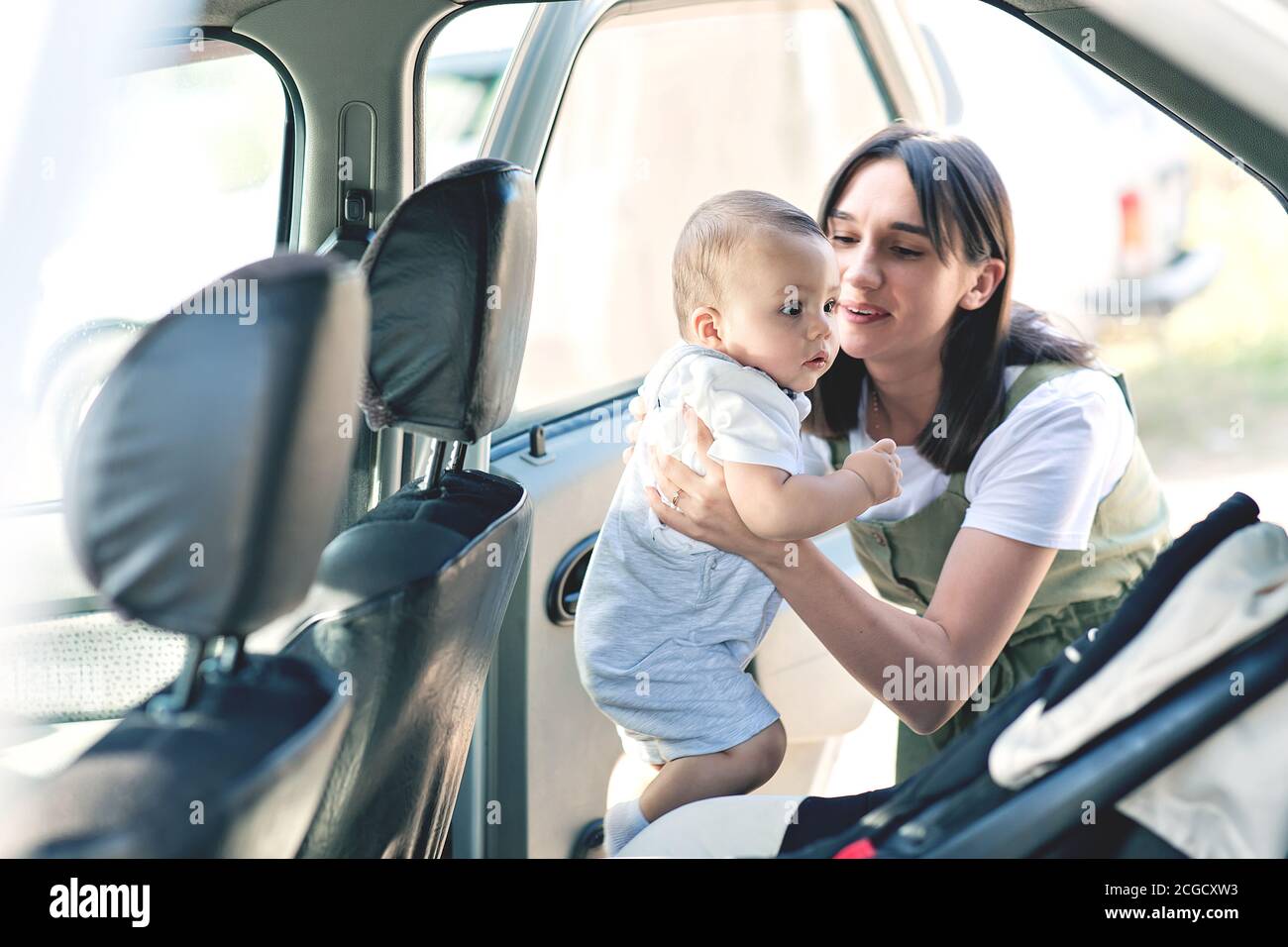 Little baby in a car seat in the car. Shot straight. The kid looks at ...