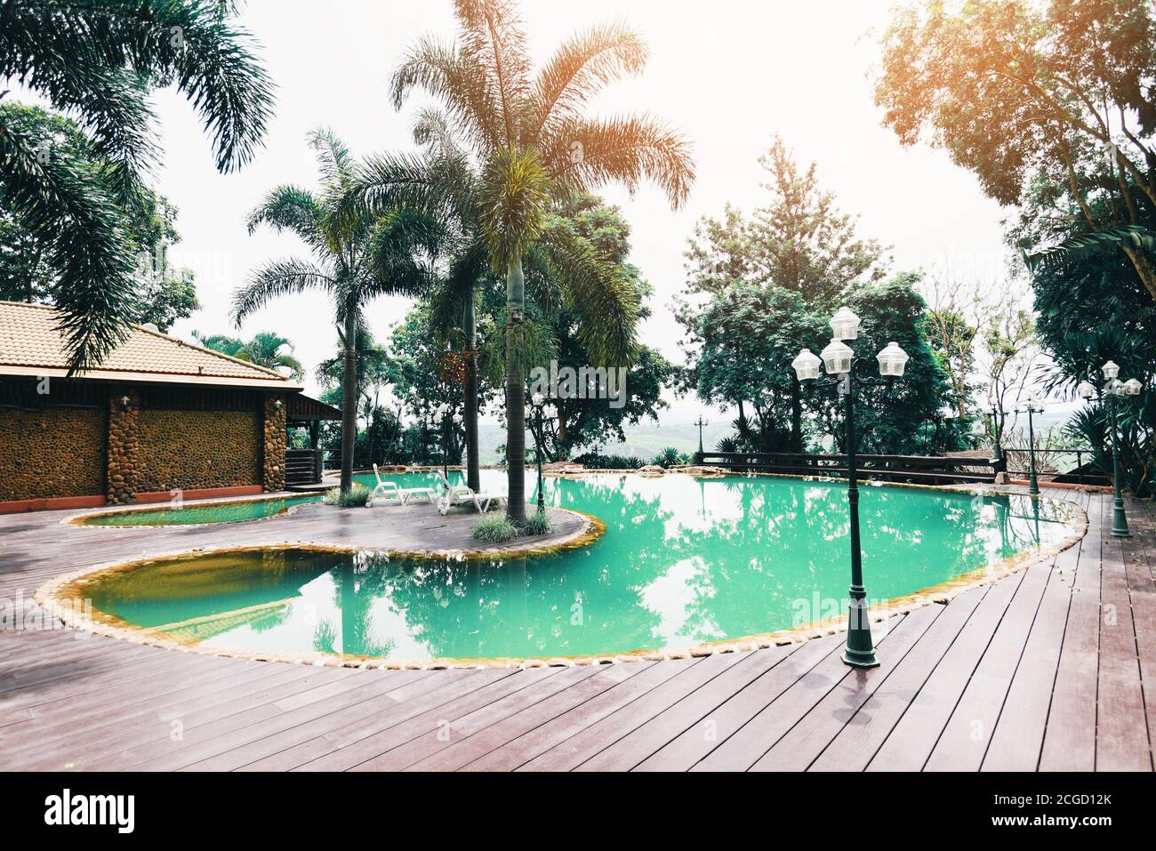 swimming pool in summer day vacation with green and blue water ...