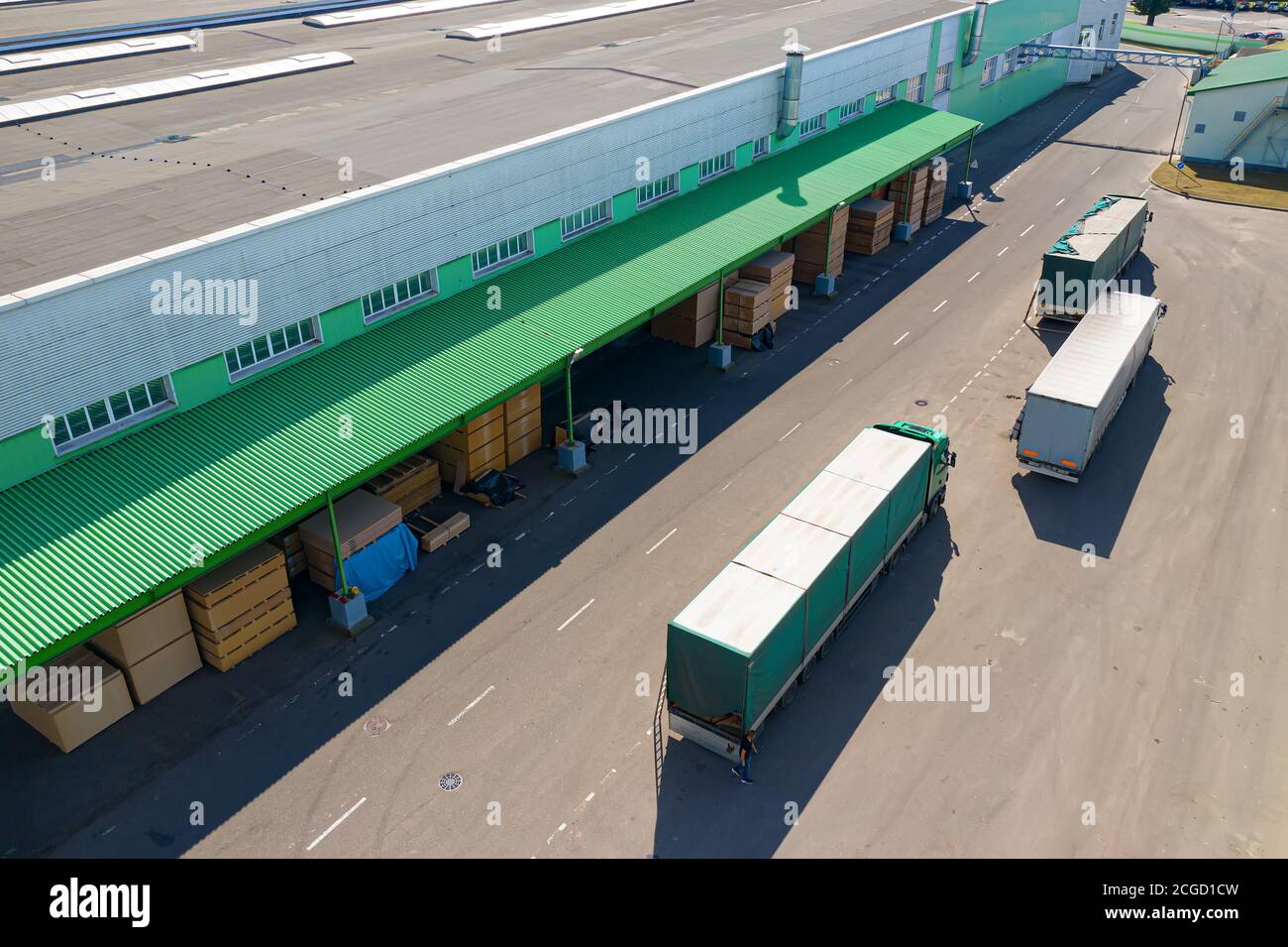 multiple trucks loading at the factory top view Stock Photo - Alamy