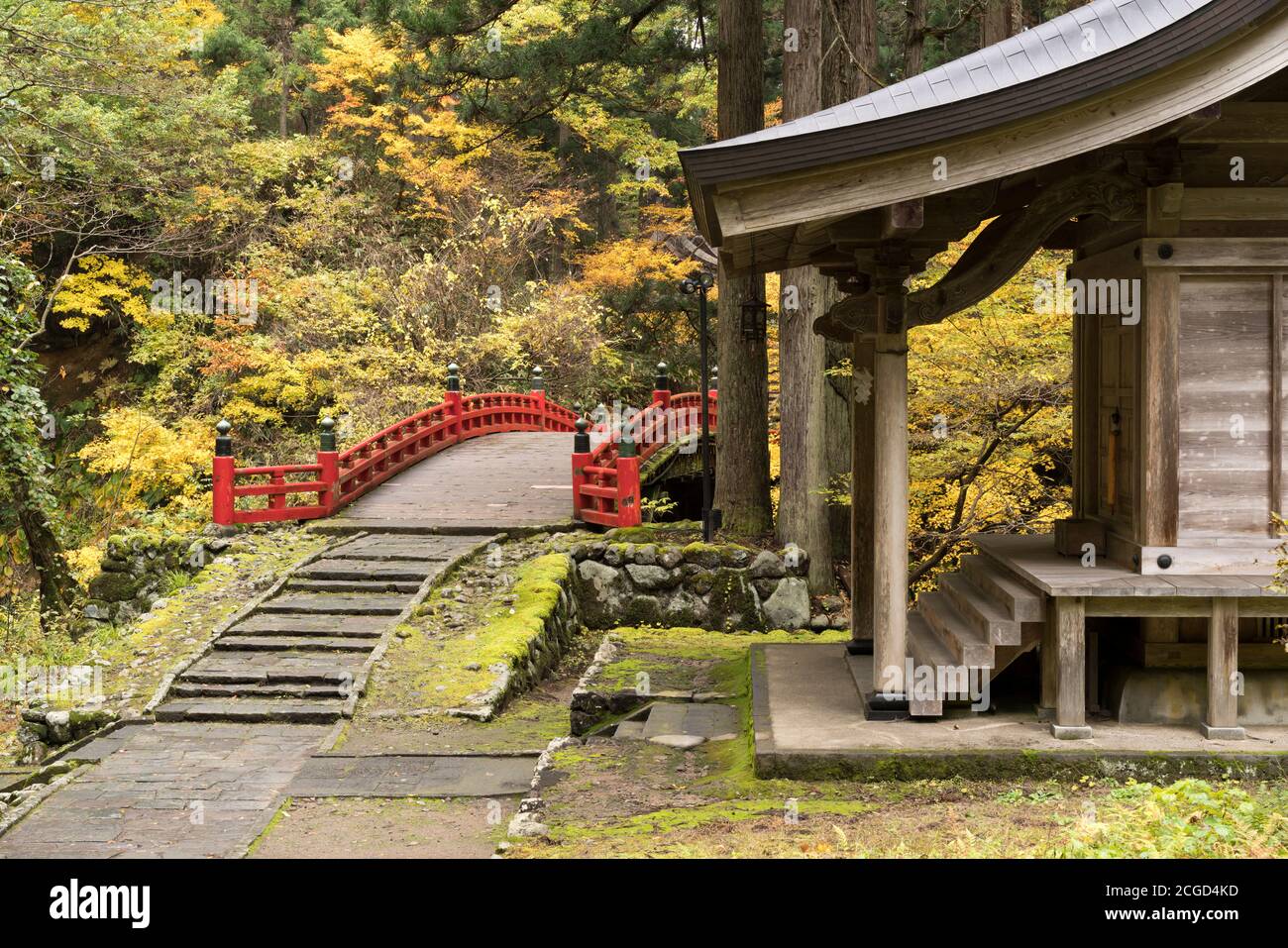 A Shinto shrine building and a red bridge at Hagurosan (Mount Haguro ...