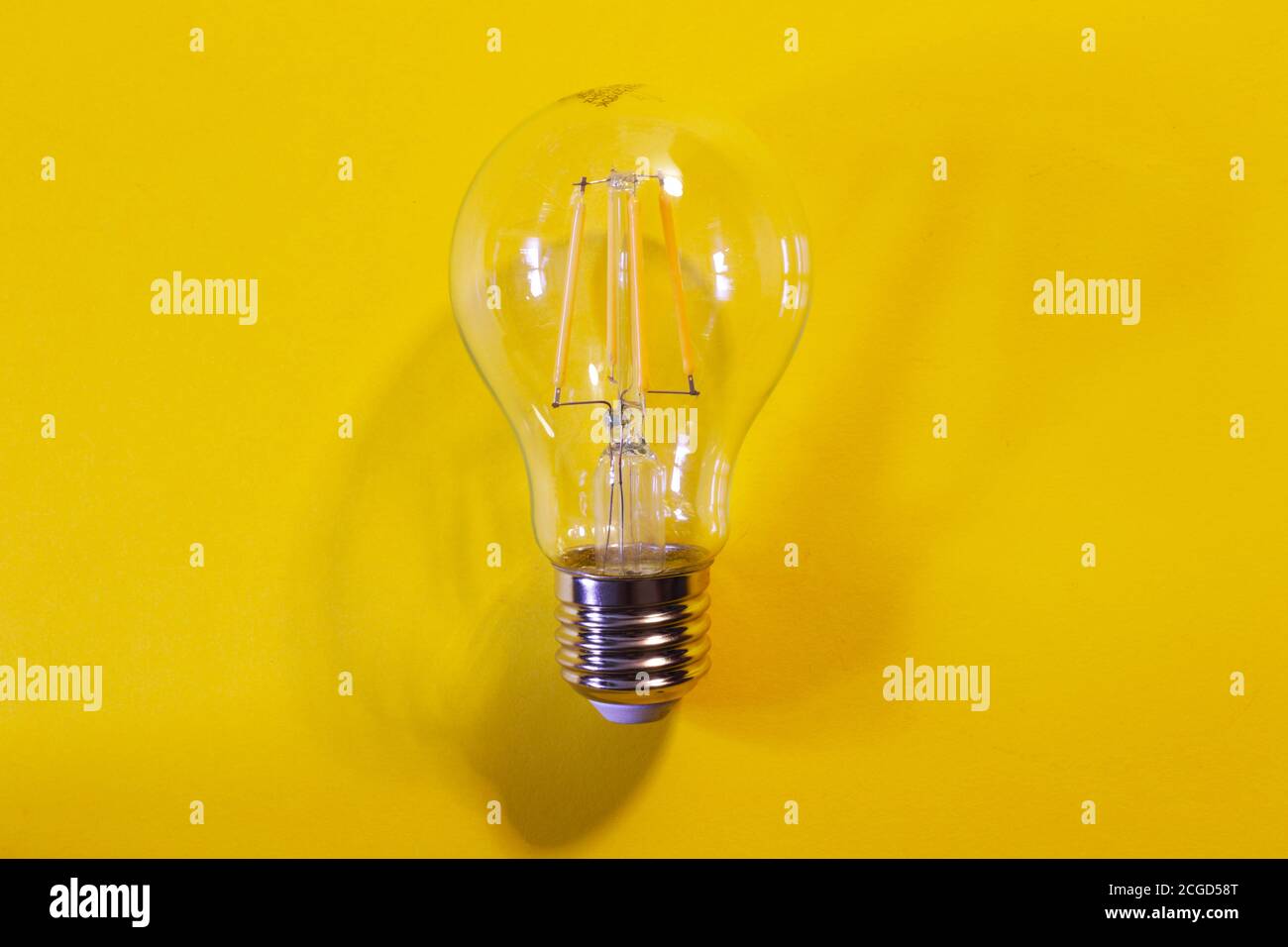 light bulb on yellow background Stock Photo - Alamy