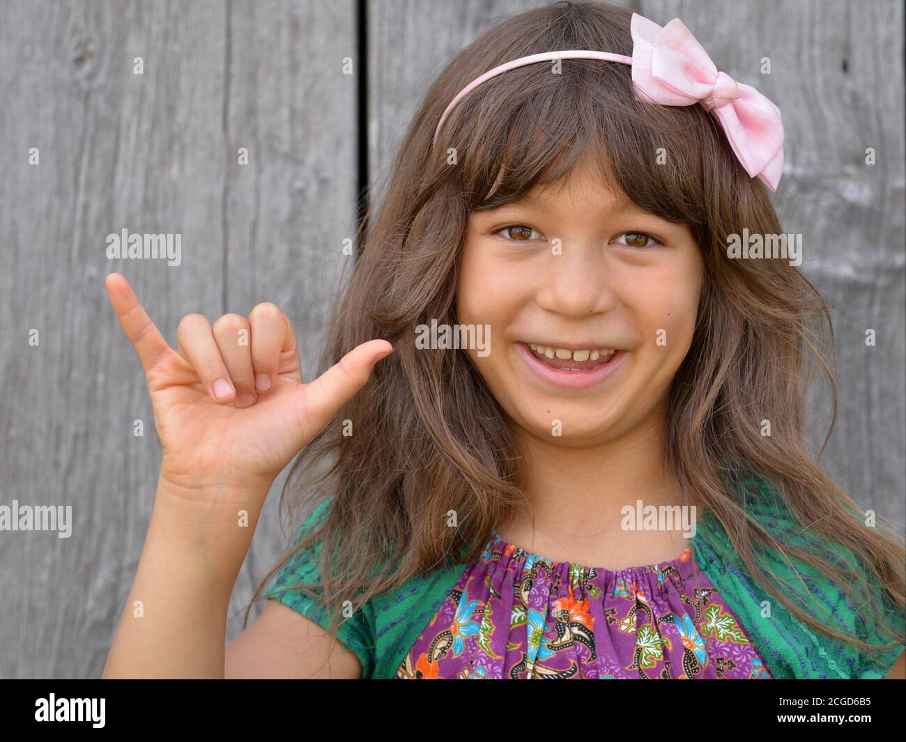 Cute mixed-race little girl (East Asian / Caucasian) shows with her ...