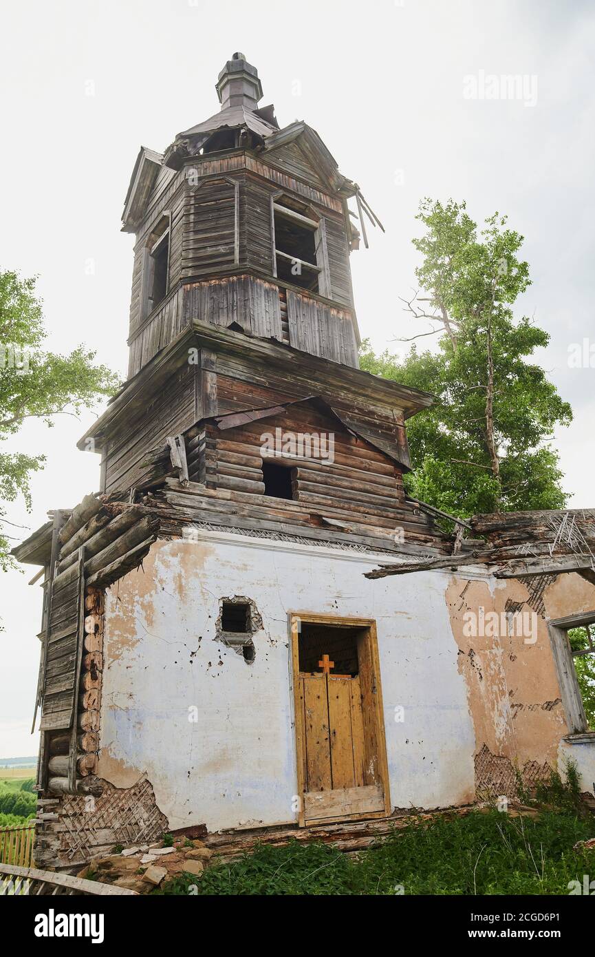 Wind damaged country church shows broken steeple. Exposed roofline has ...