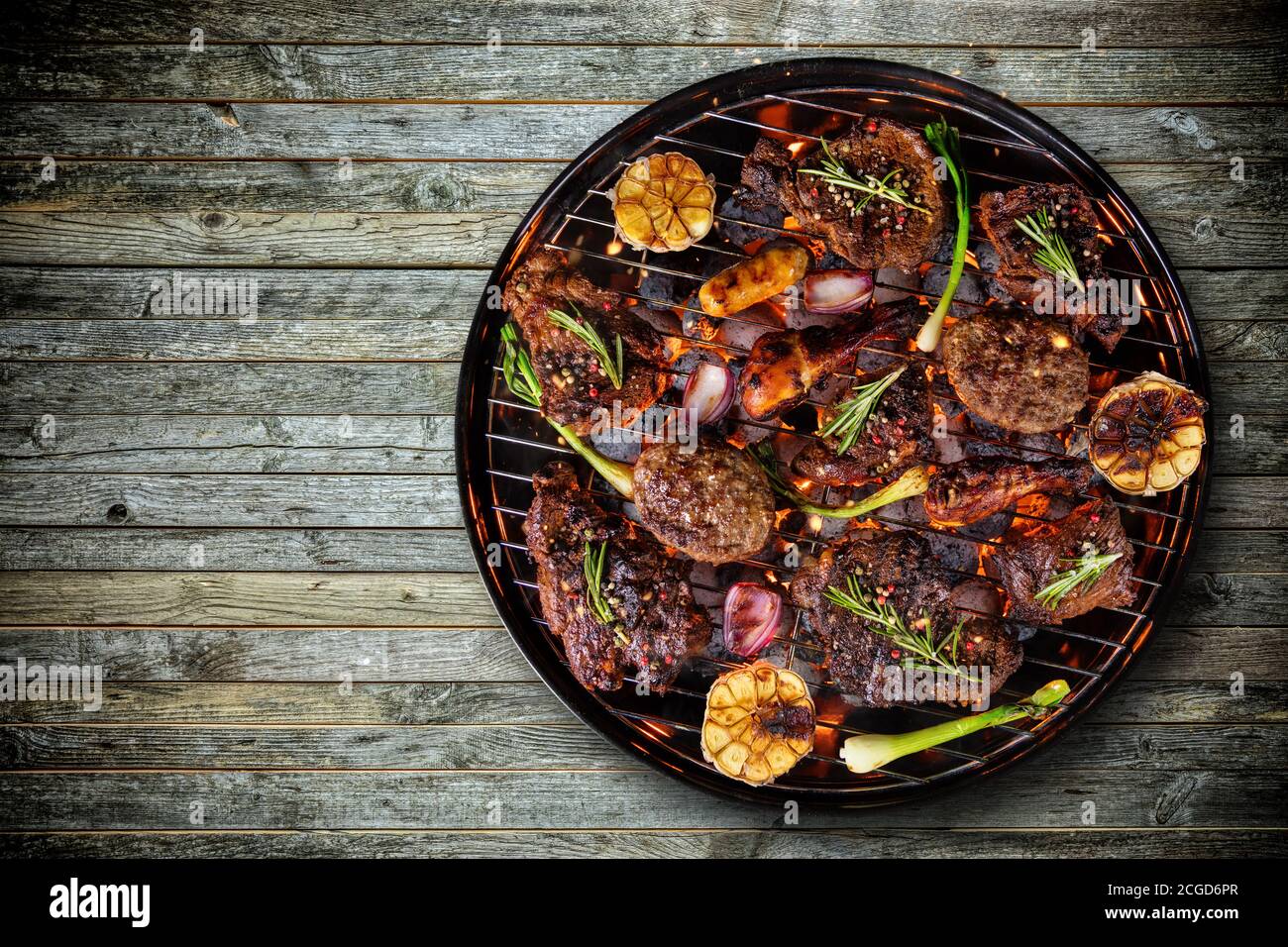 Top view of fresh beef steaks, chicken legs, sausage and vegetable on ...