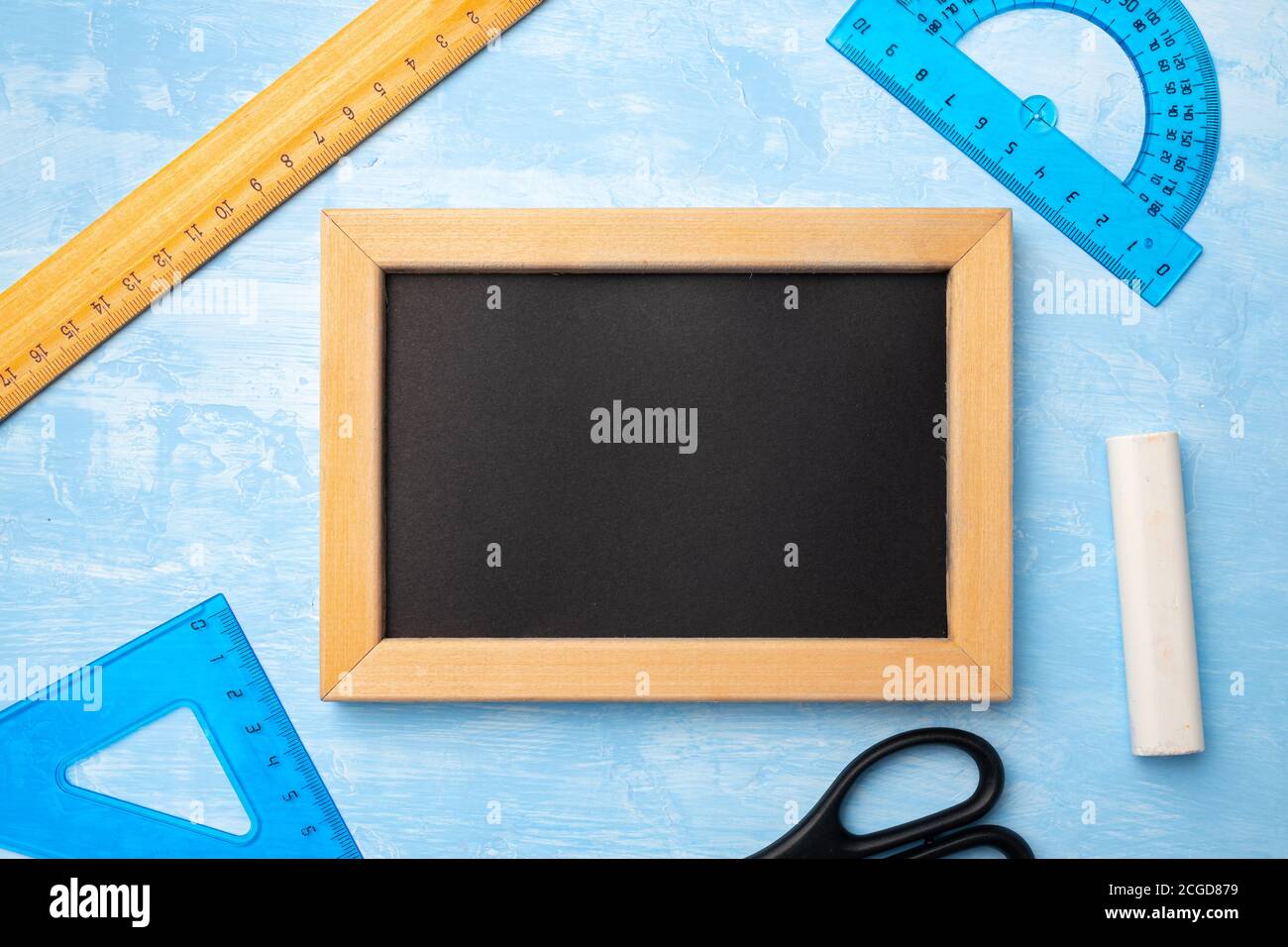 Mini blackboard in wooden frame and school supplies Stock Photo - Alamy