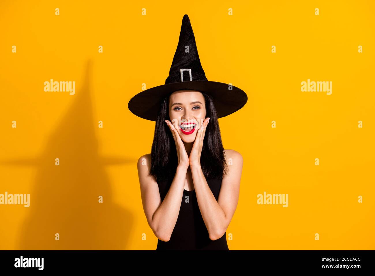 Photo of cute charming young magician lady hands face open mouth ...