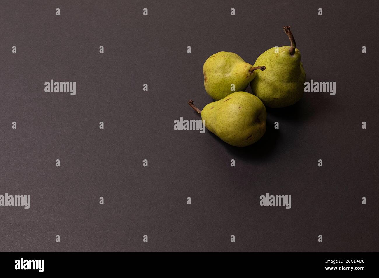 Still life of pears on black background. Low key photography. Set of ...