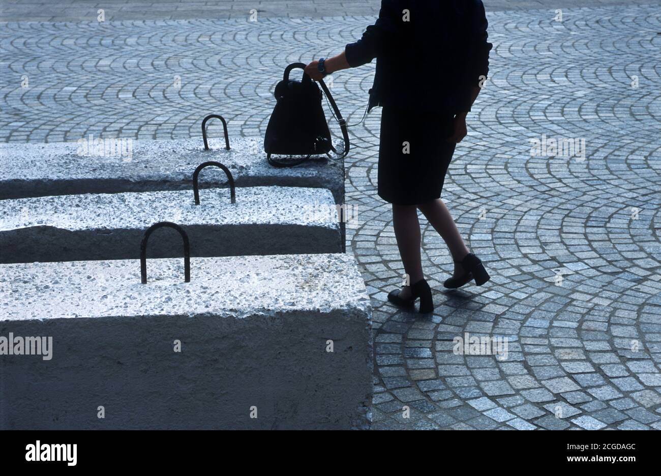 Woman picking up her bag Stock Photo - Alamy