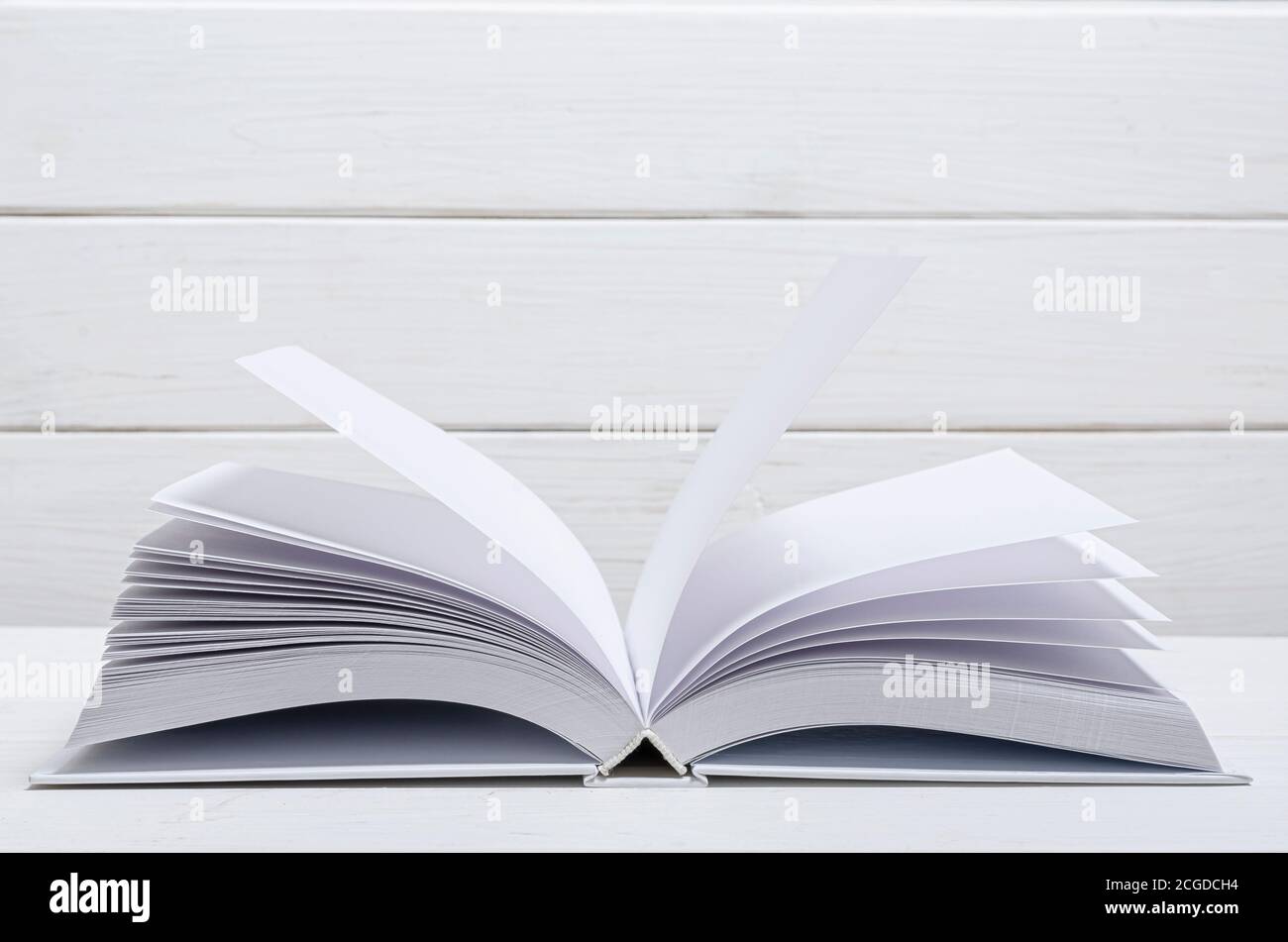 White new open book with clean empty pages lies on a wooded table Stock ...