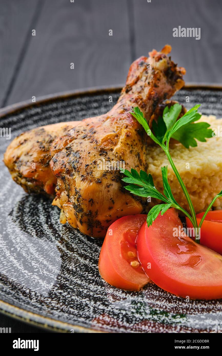 Close up view of fried chicken leg with millet porridge Stock Photo - Alamy